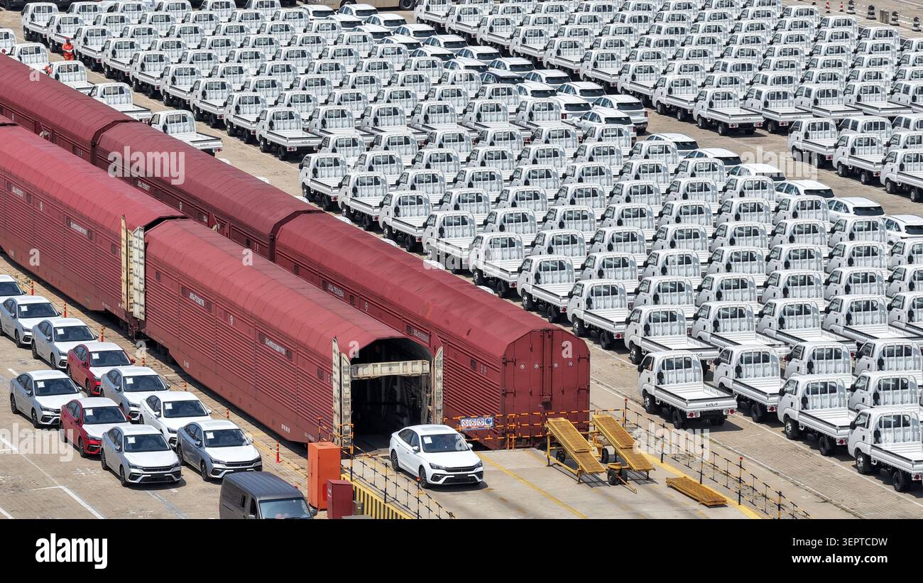 New vehicles wait for shipment to overseas markets in a port in Yantai ...