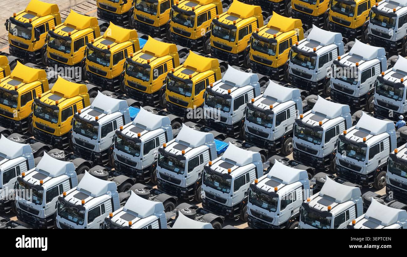 New trucks wait for shipment to overseas markets in a port in Yantai in ...