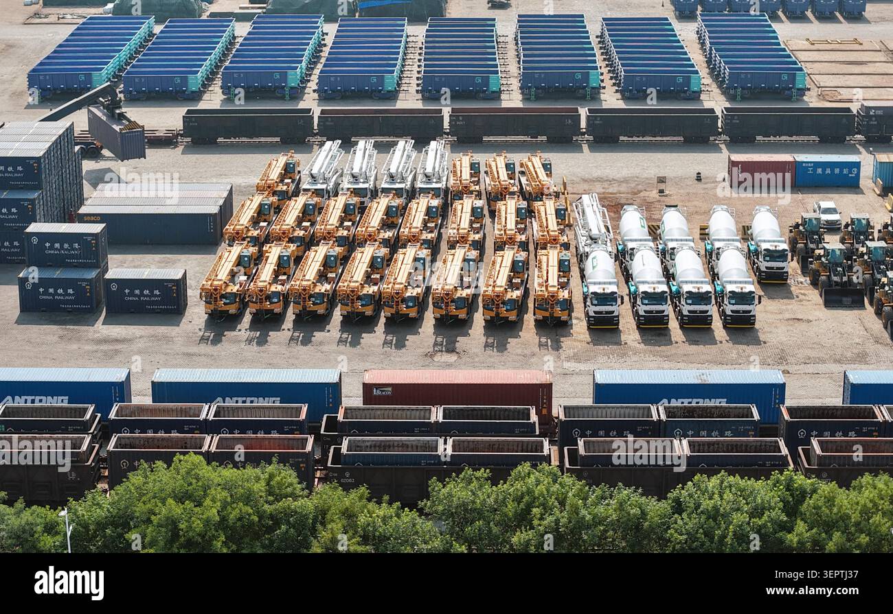 Containers, engineering vehicles and train carriages are transported by ...