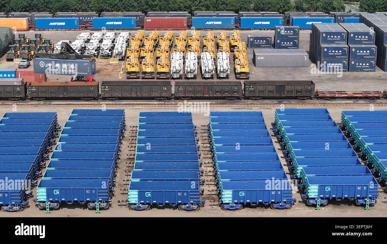 Containers, engineering vehicles, and train carriages are transported ...