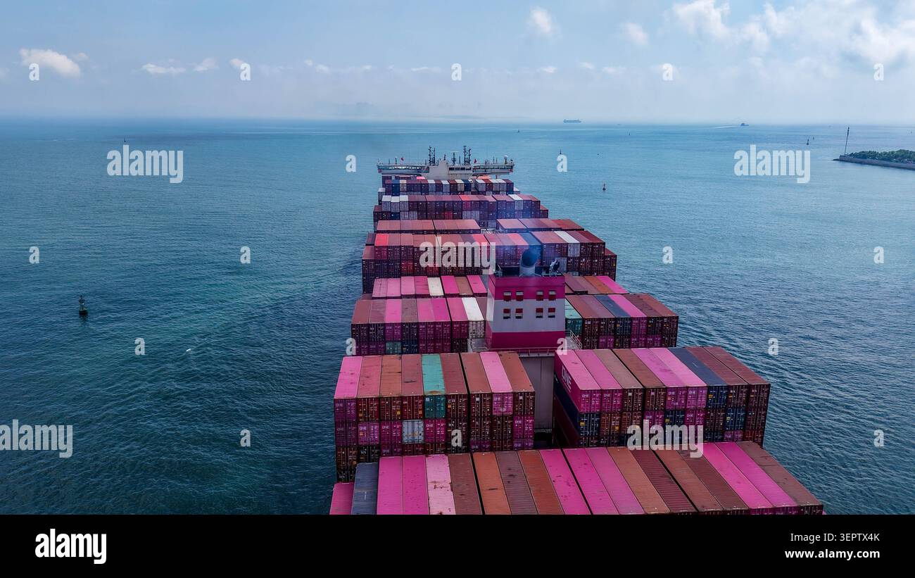 A container ship arrives at Qingdao Port in east China's Shandong ...
