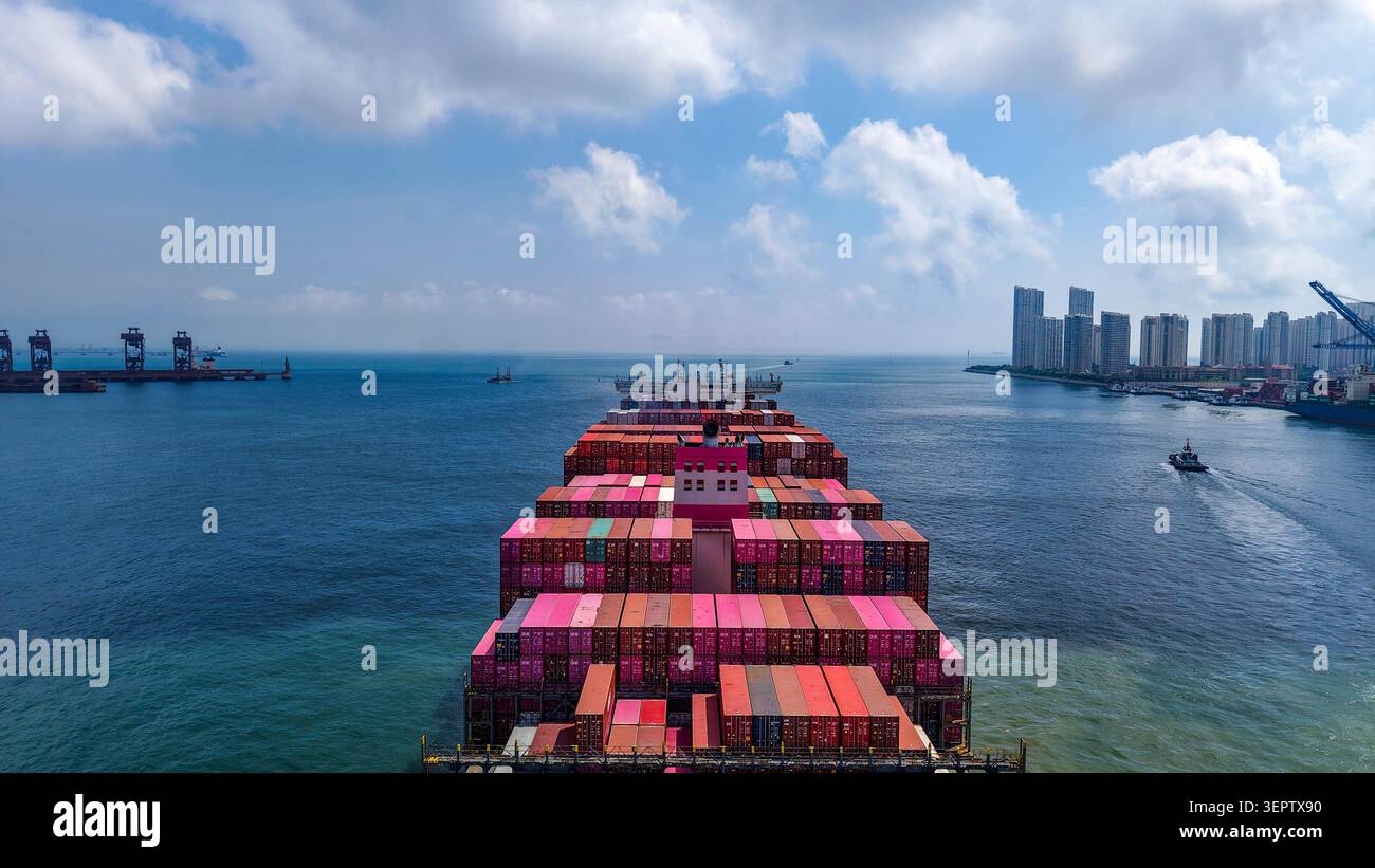 A container ship arrives at Qingdao Port in east China's Shandong ...