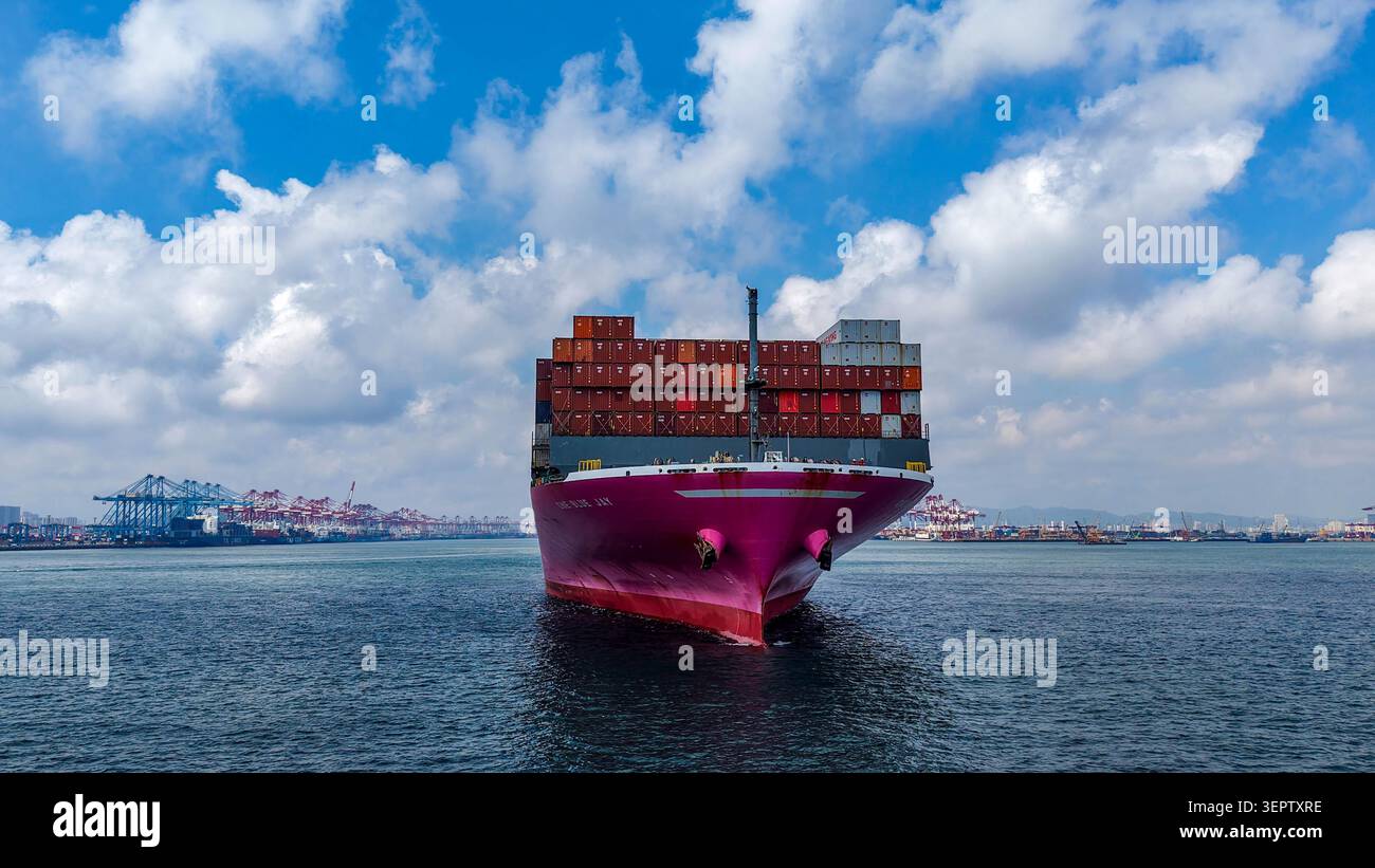A container ship arrives at Qingdao Port in east China's Shandong ...