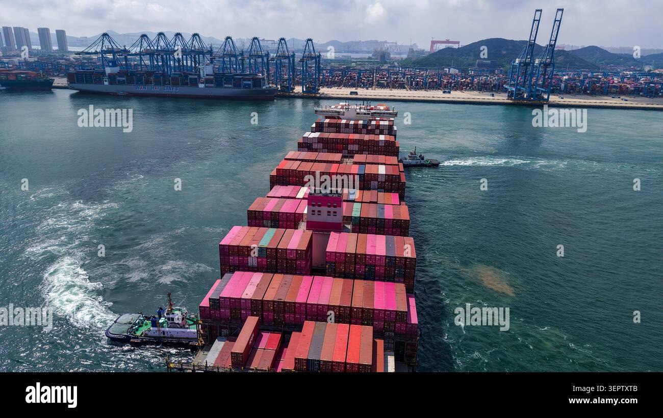 A container ship arrives at Qingdao Port in east China's Shandong ...