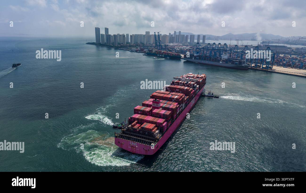 A container ship arrives at Qingdao Port in east China's Shandong ...