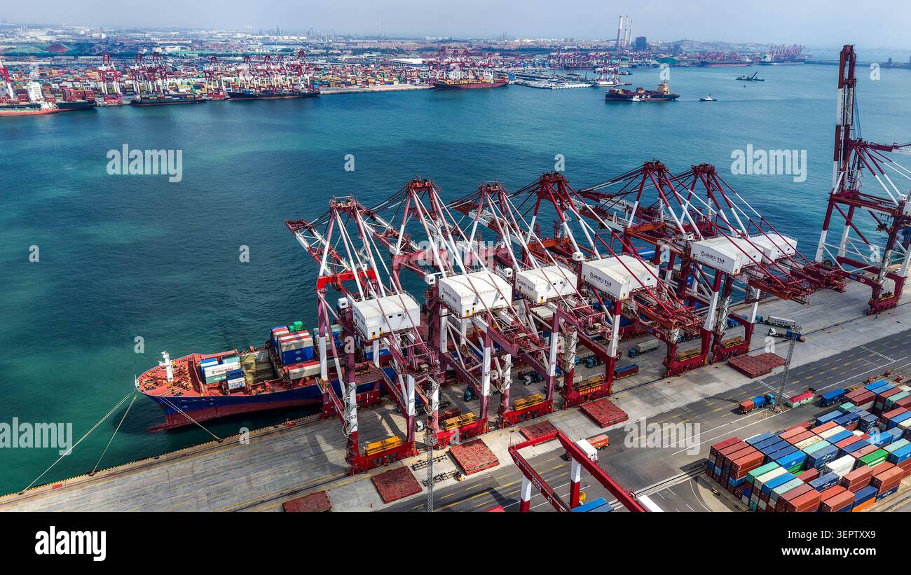 A container ship arrives at Qingdao Port in east China's Shandong ...