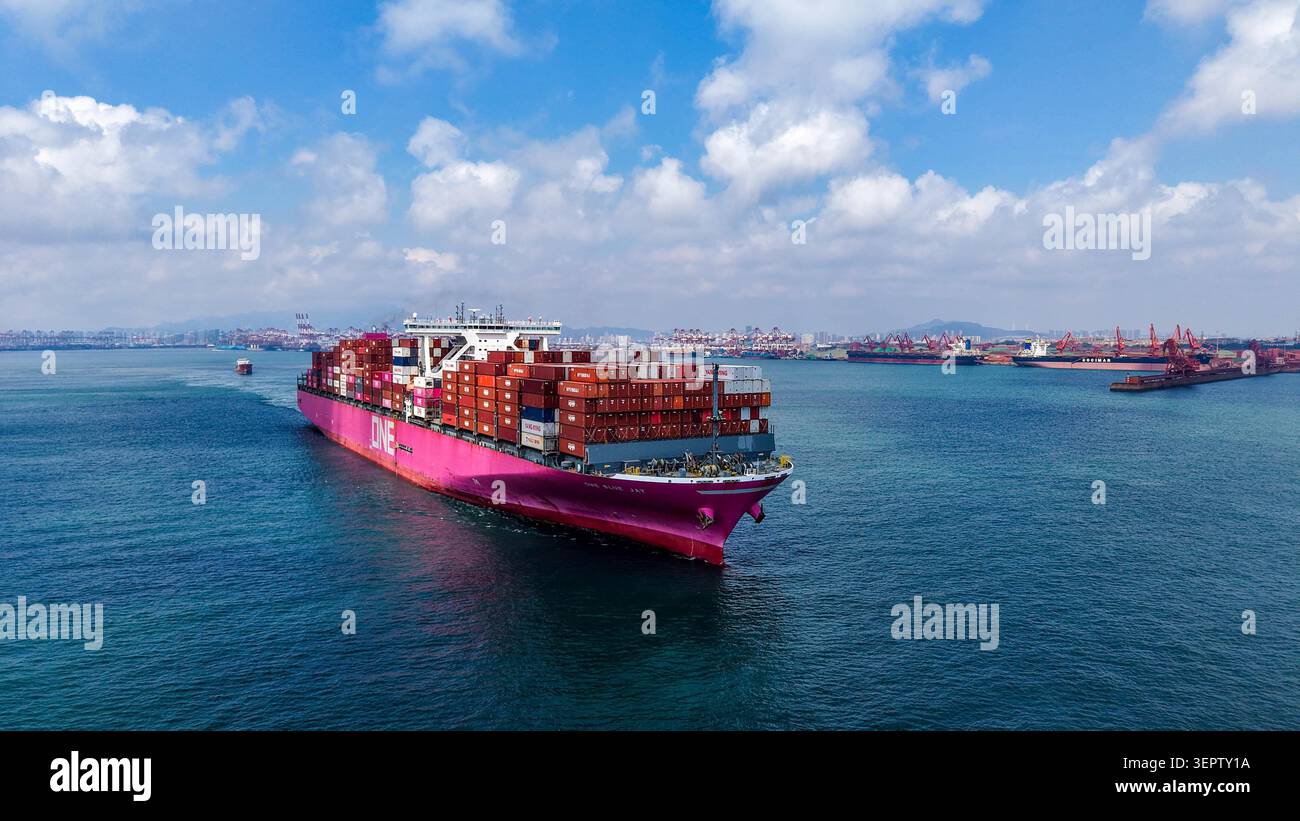A container ship arrives at Qingdao Port in east China's Shandong ...