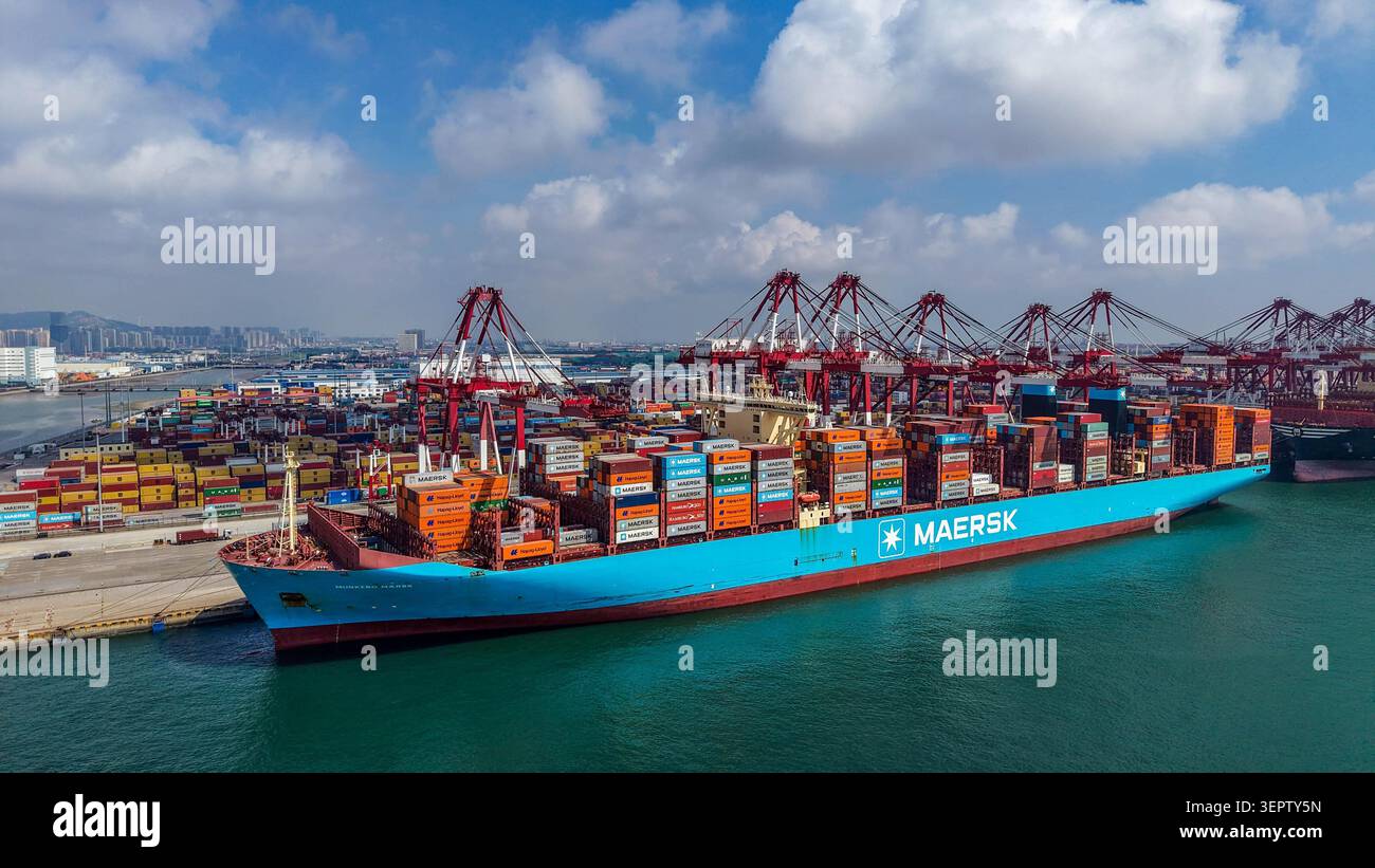 A container ship arrives at Qingdao Port in east China's Shandong ...