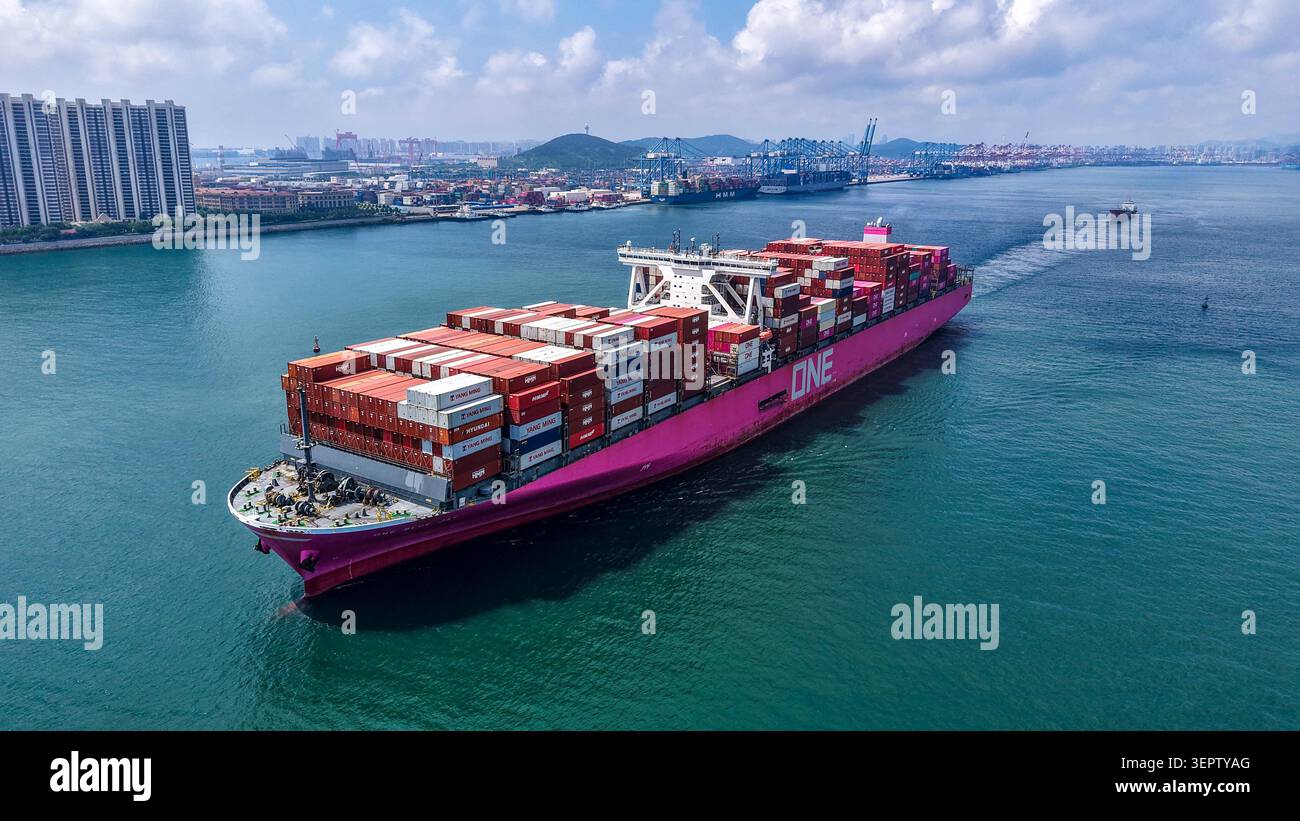 A container ship arrives at Qingdao Port in east China's Shandong ...