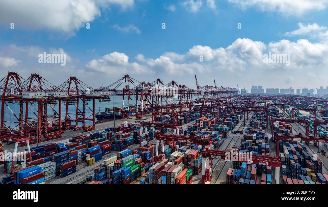 A container ship arrives at Qingdao Port in east China's Shandong ...