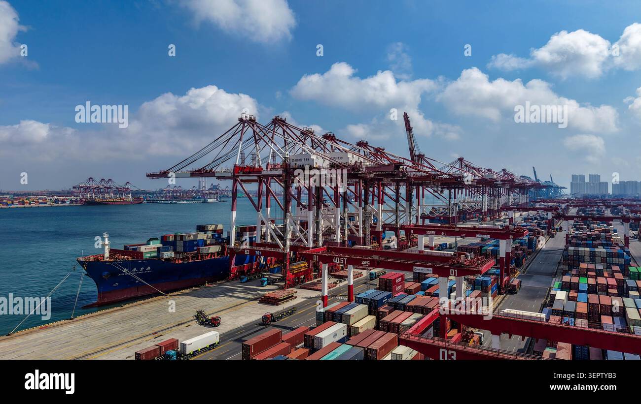 A container ship arrives at Qingdao Port in east China's Shandong ...