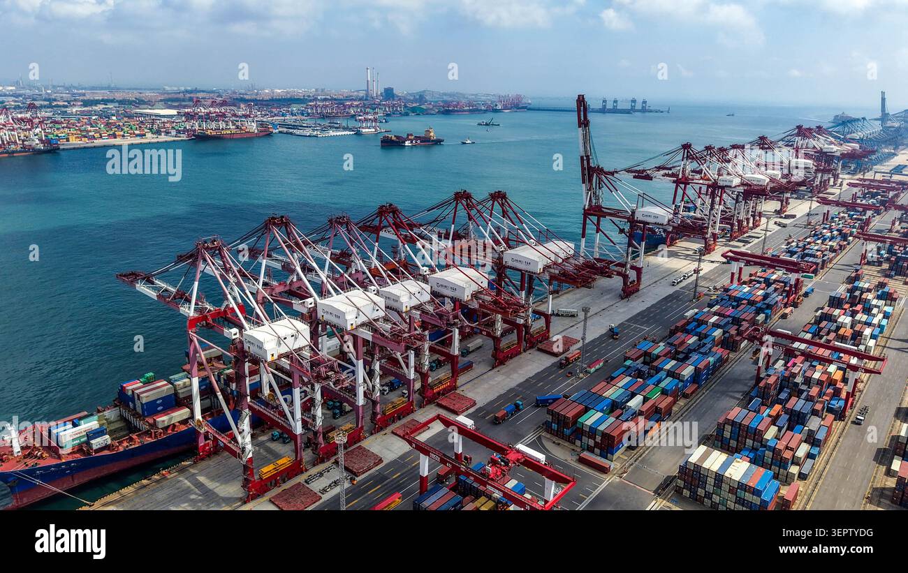 A container ship arrives at Qingdao Port in east China's Shandong ...