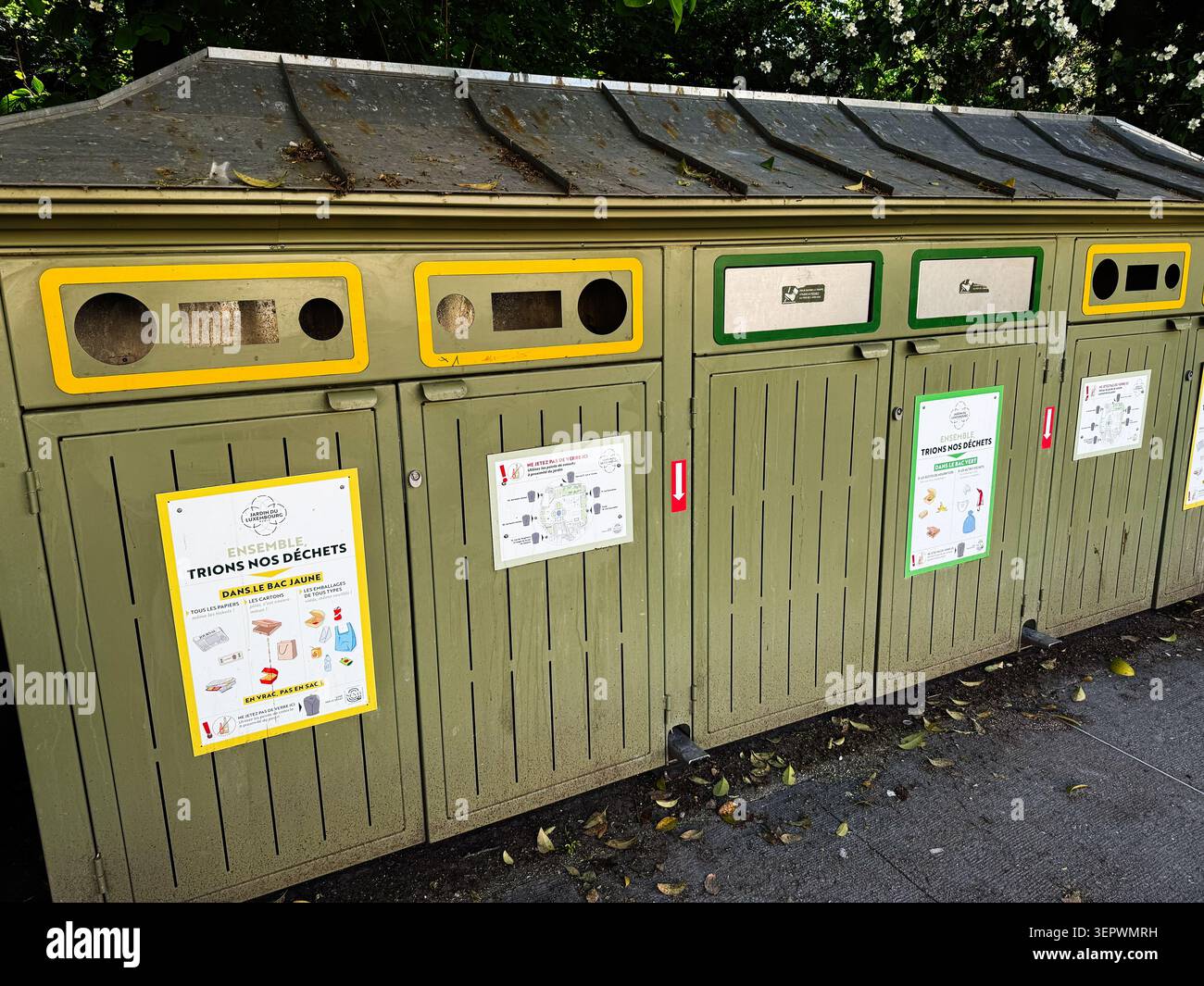 Paris, France - May 14, 2026: Green communal recycling bins with ...