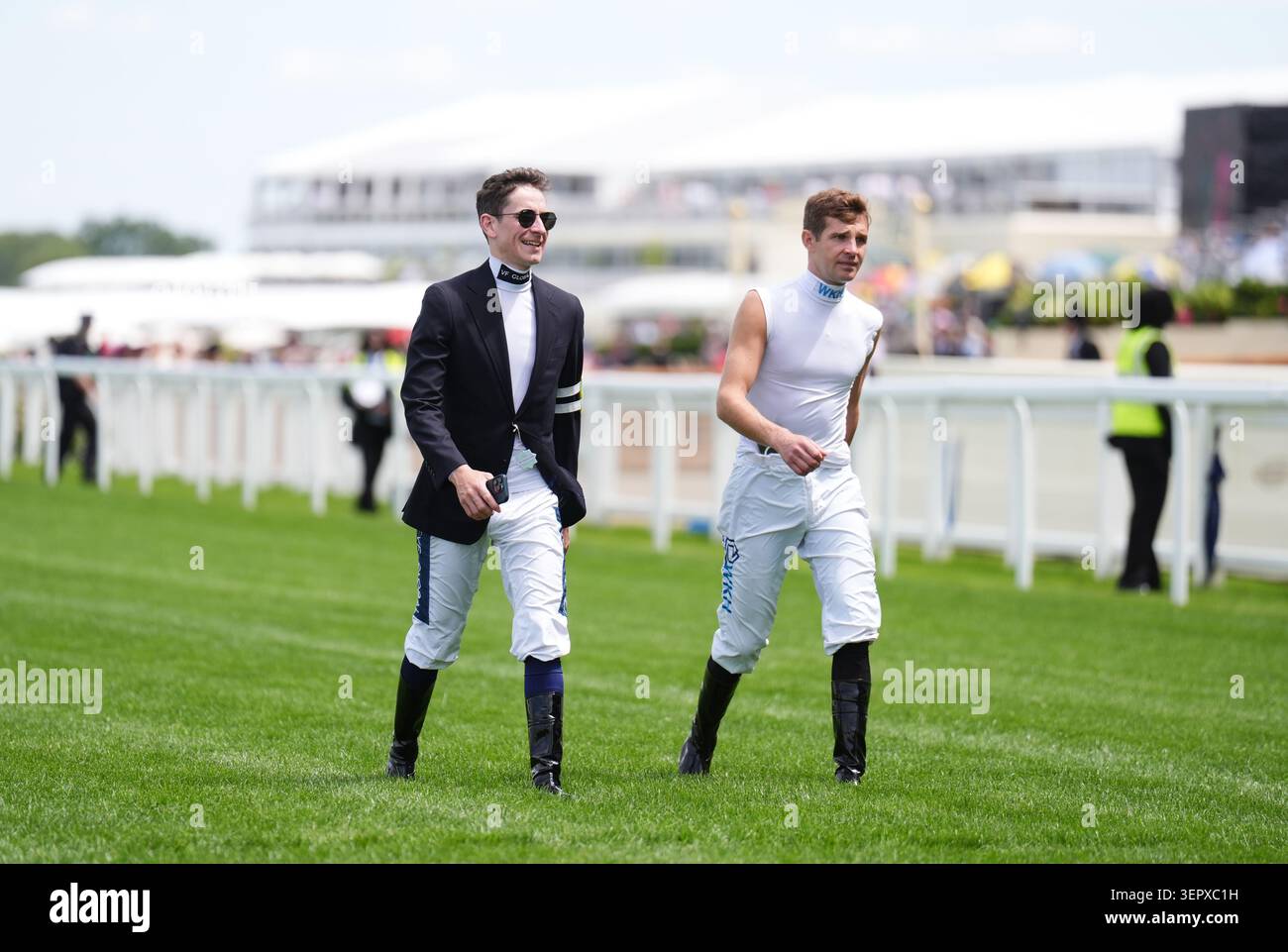 Jokceys Hector Crouch (left) and Charles Bishop walk the course during ...