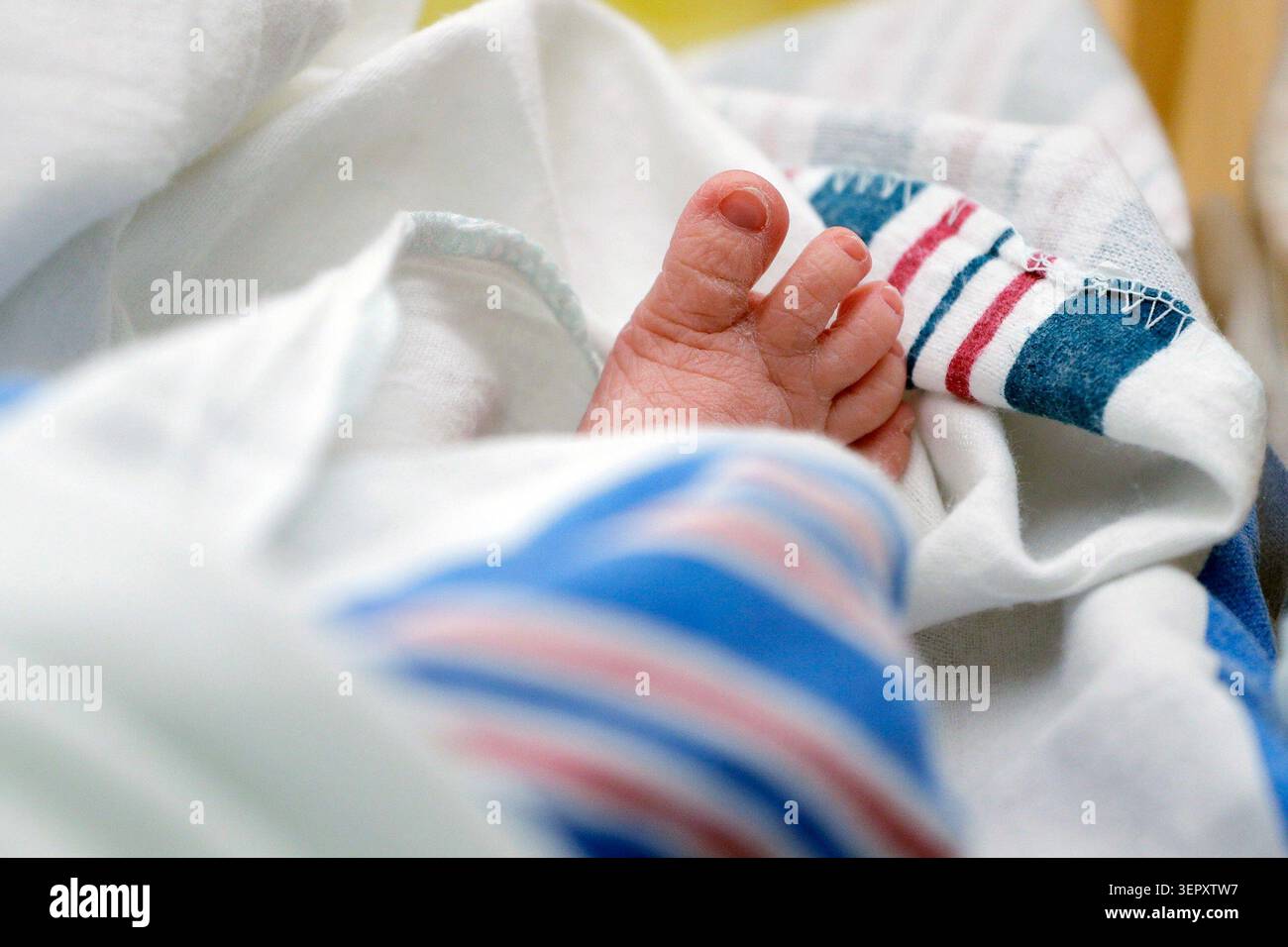 FILE - The toes of a baby peek out of a blanket at a hospital in ...