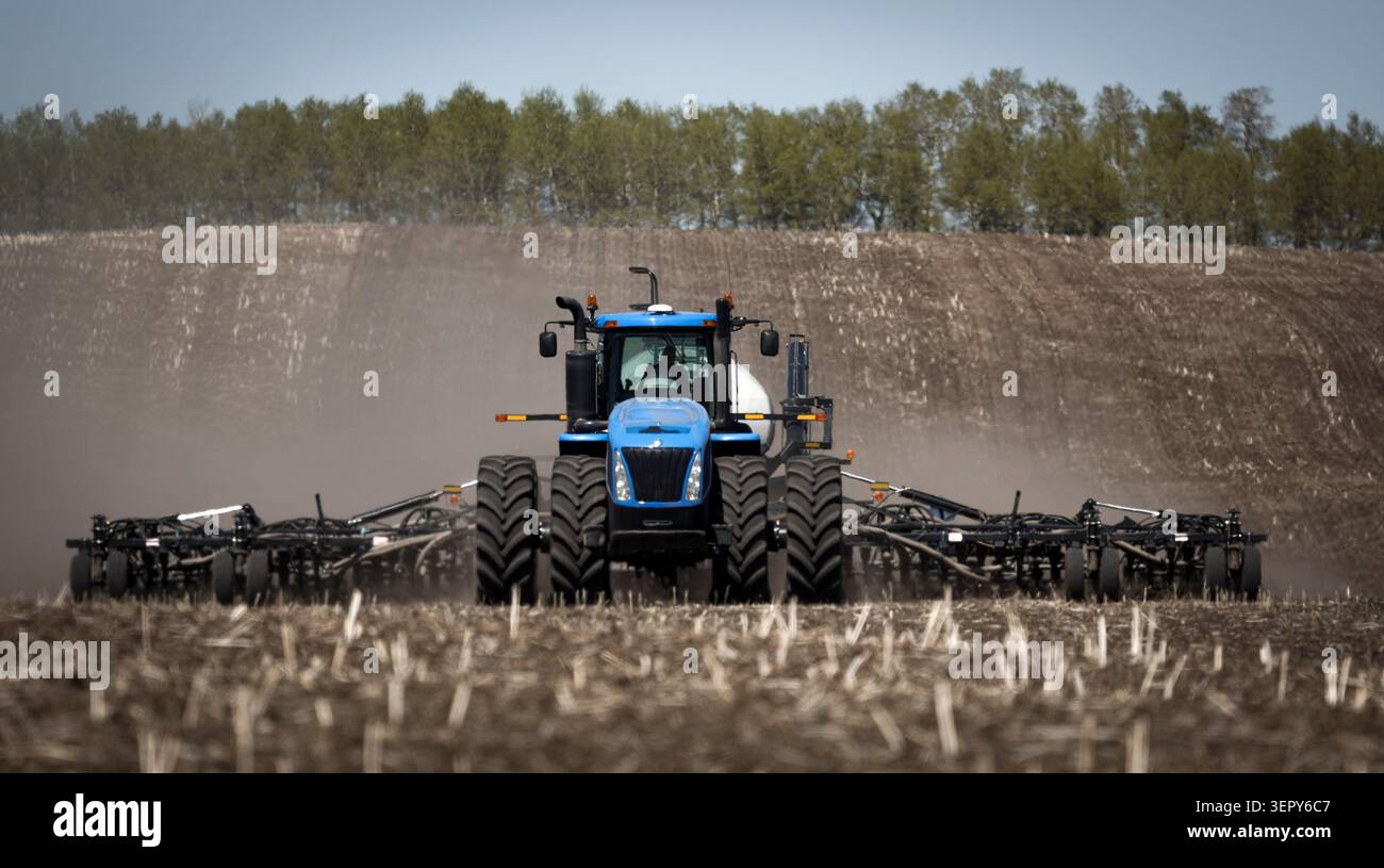 David Reid drives a seeding rig as he plants a wheat crop on the family ...
