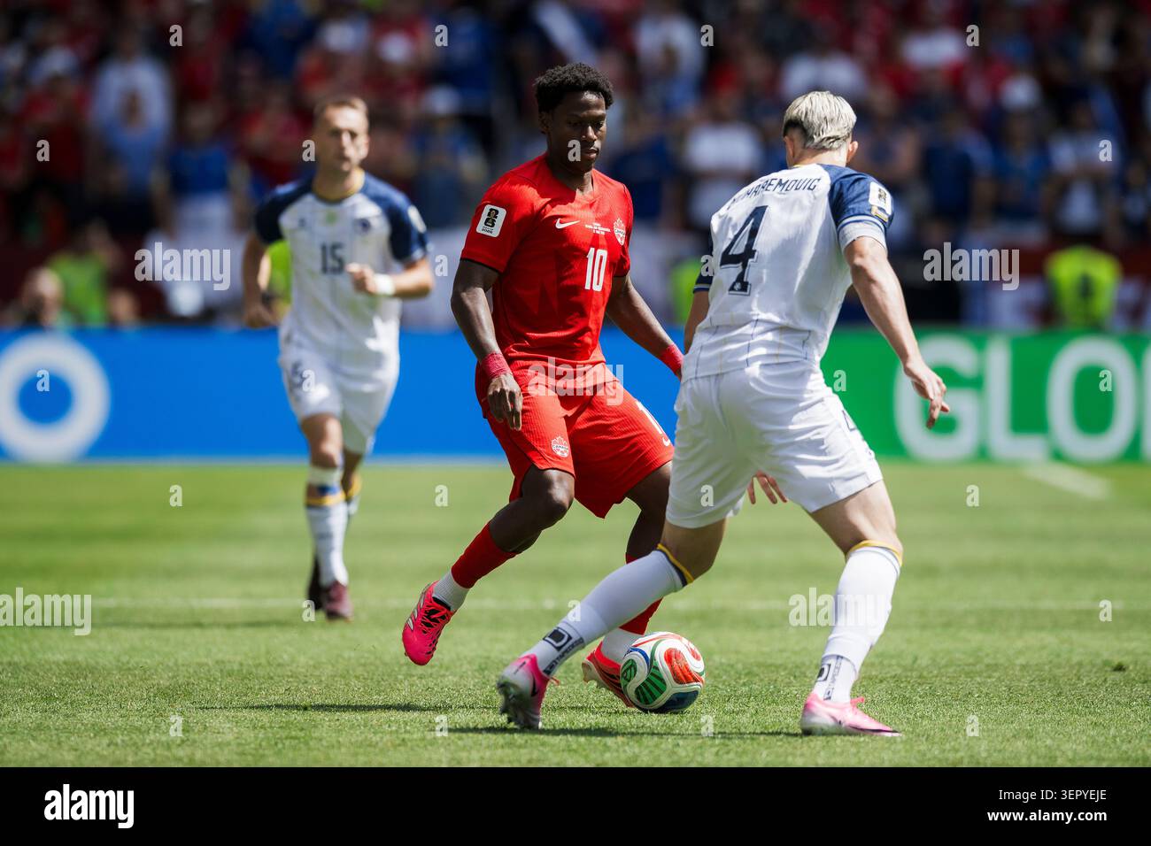 Jonathan David of Canada is chalenged by Tarik Muharemovic of Bosnia ...