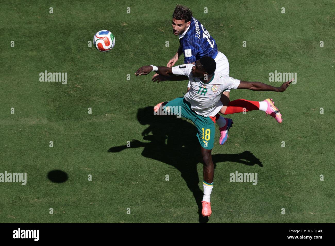 France's Theo Hernandez, top, and Senegal's Ismaila Sarr jump for the ...