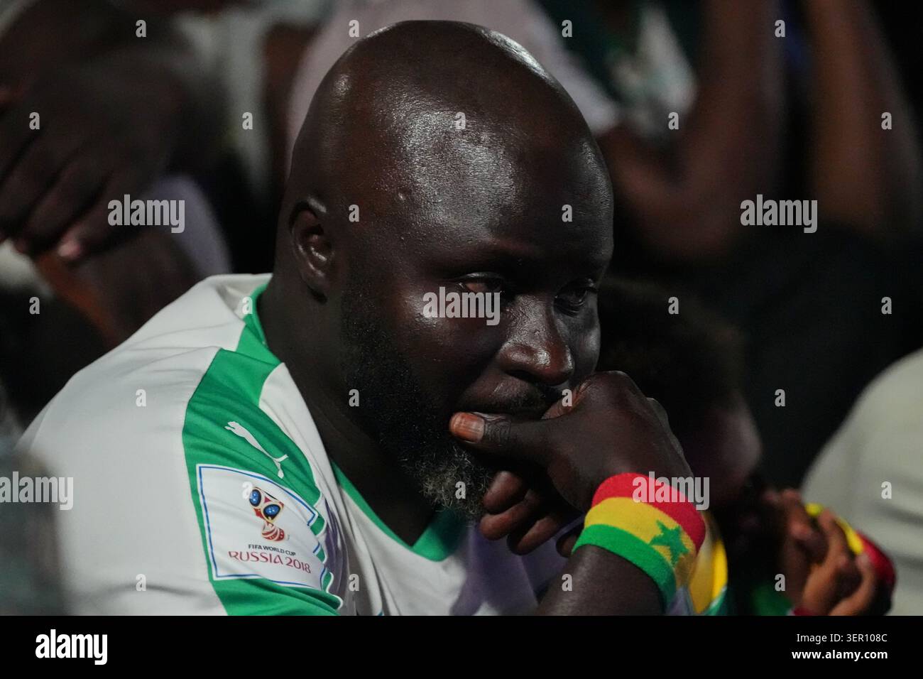 A Senegalese fan reacts as he watches a broadcast of the World Cup ...