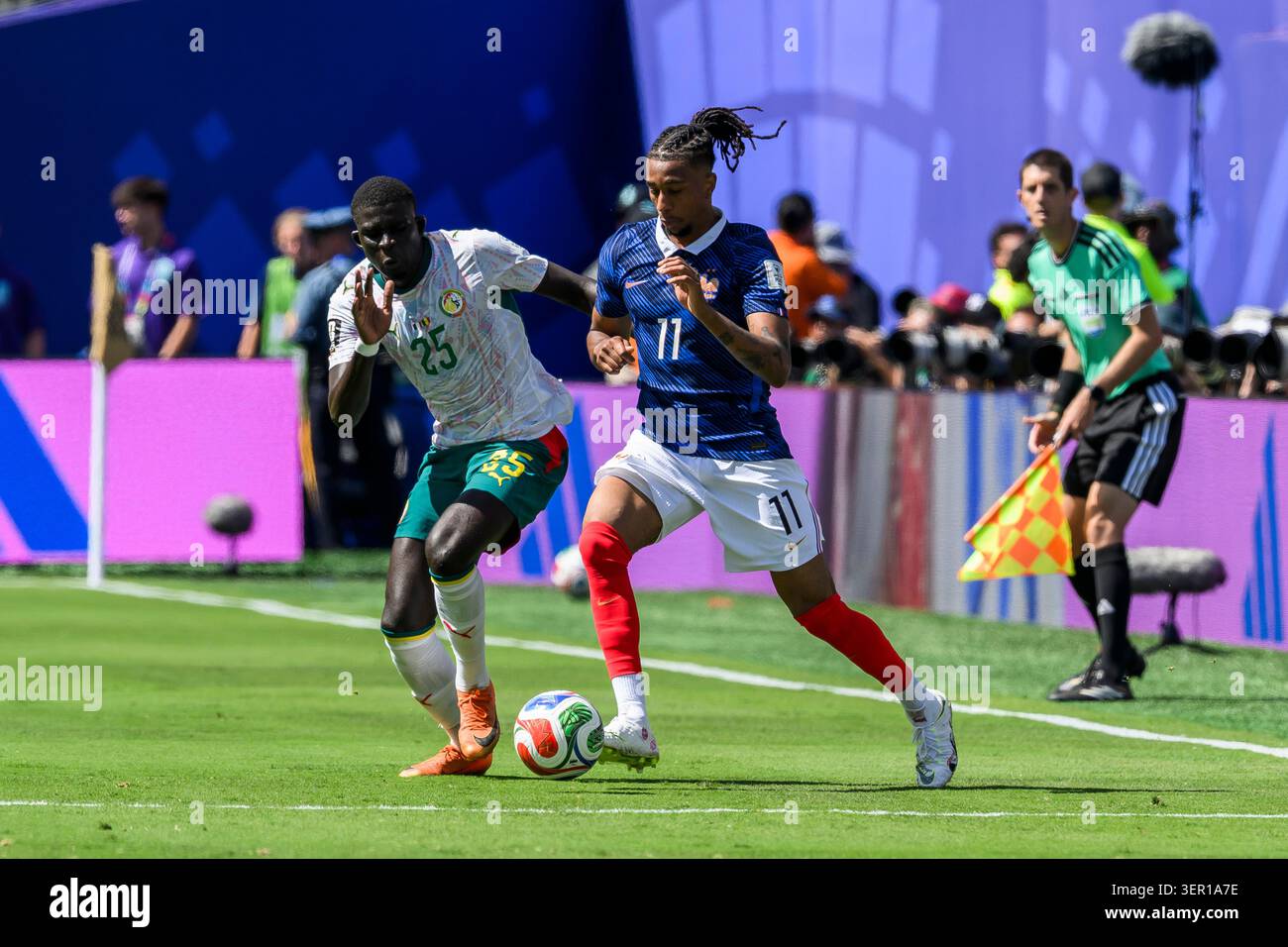 Michael Olise of France competes for the ball with El Hadji Malick ...