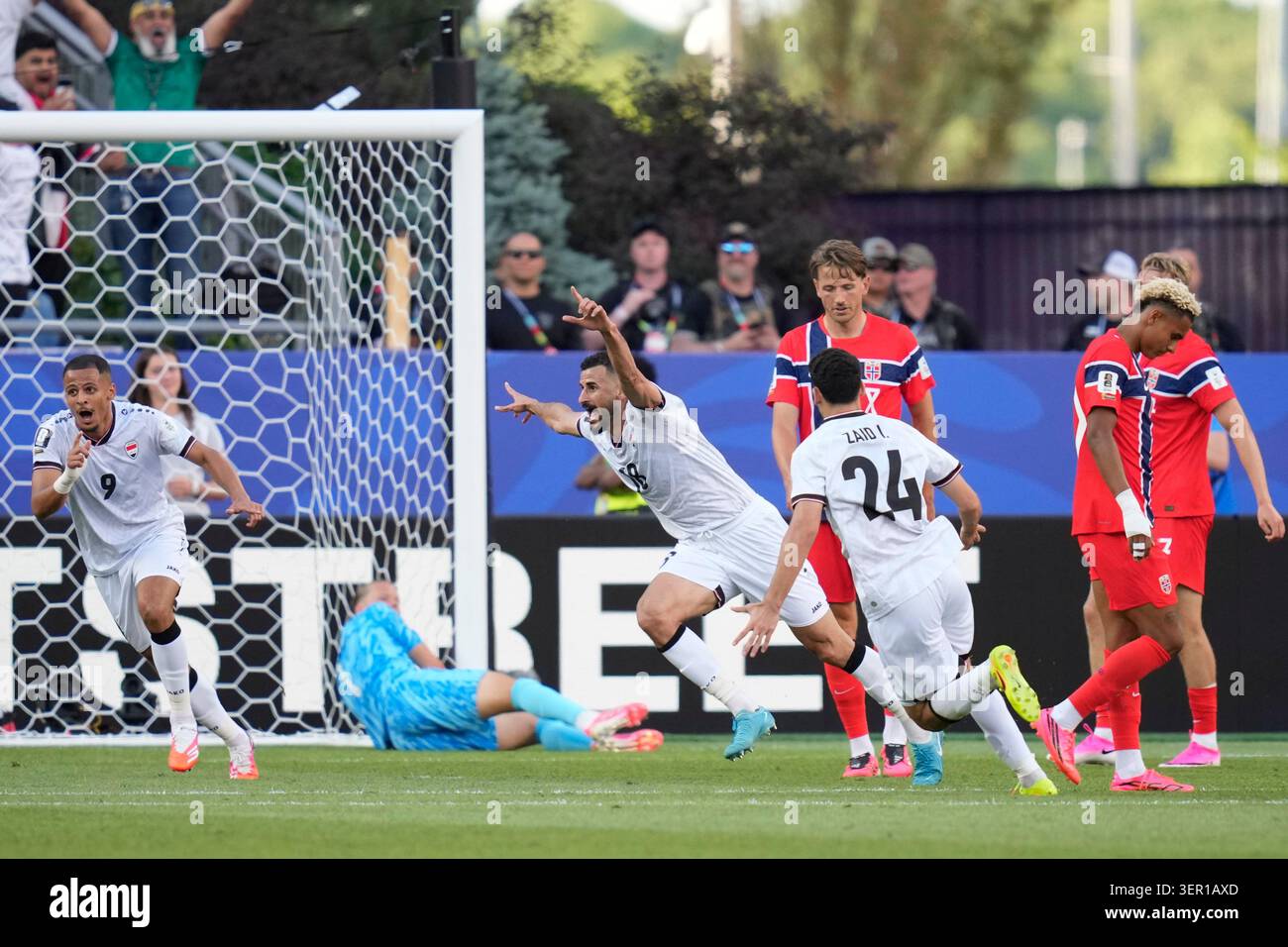 Iraq's Aymen Hussein (18), center, celebrates after scoring his side's ...