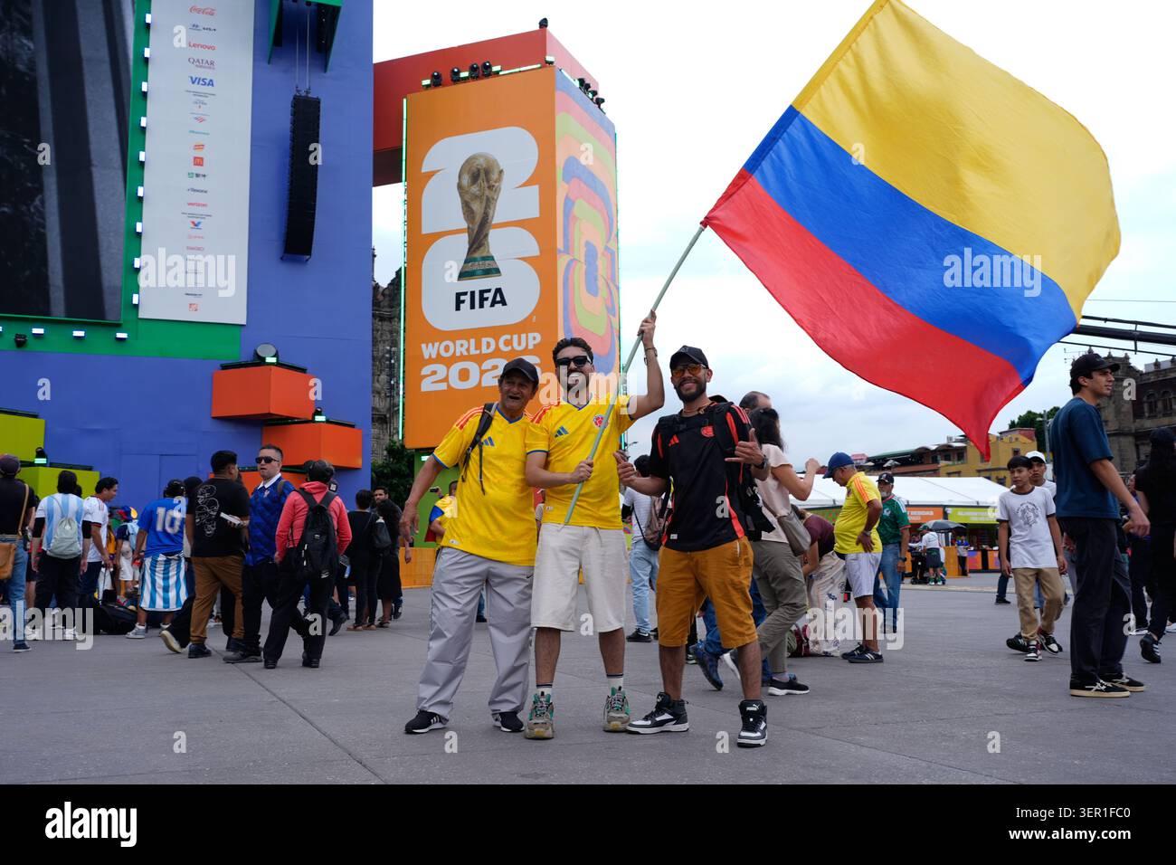Colombians soccer fans pose for a photo with their national flag in the ...