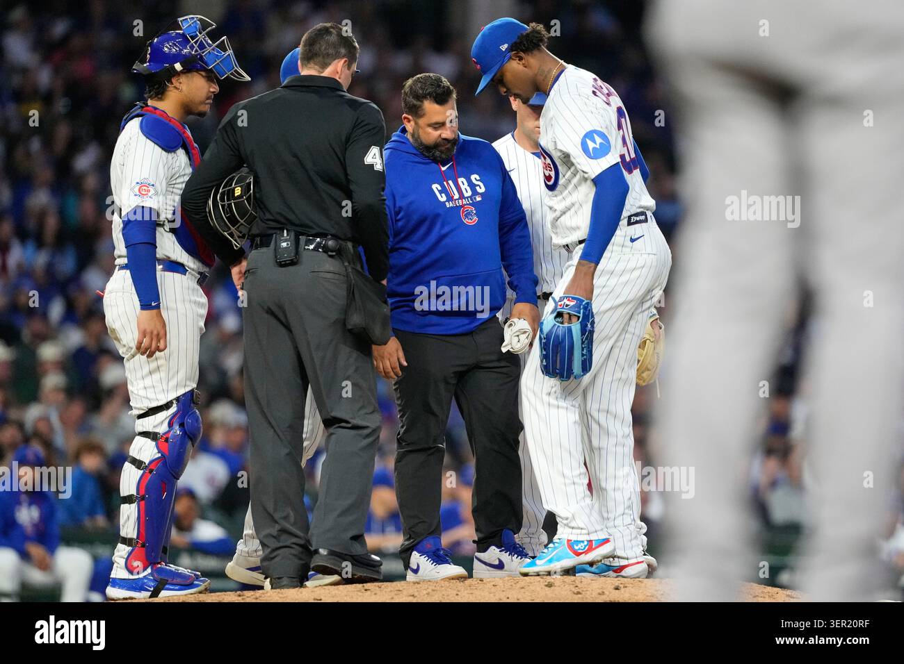 Chicago Cubs starting pitcher Edward Cabrera, right, is checked by a ...