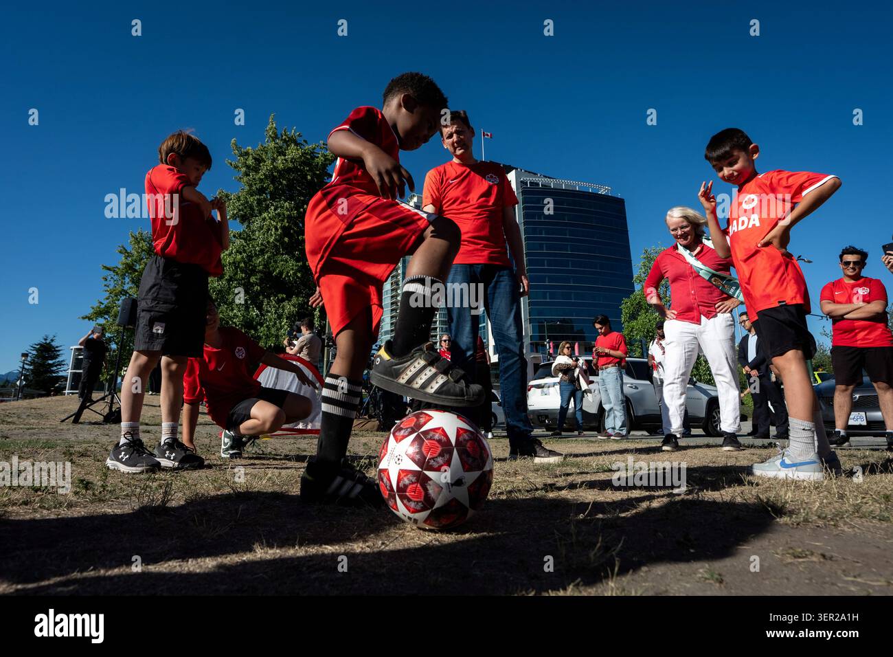 B.C. Premier David Eby plays soccer with kids before a rally, in ...