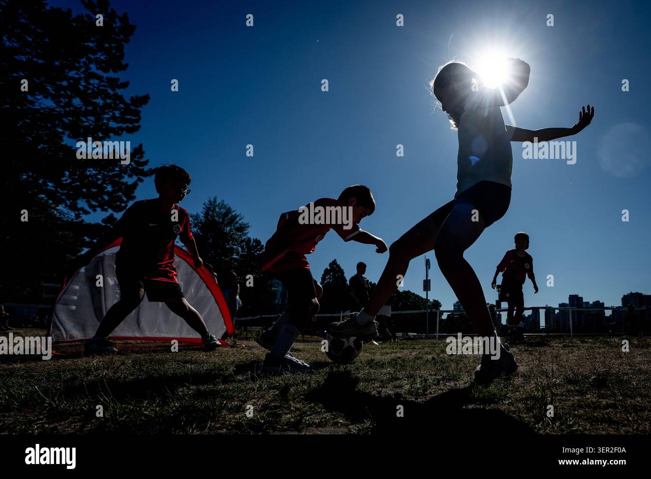 Children play soccer before a Canada FIFA World Cup rally, in Vancouver ...
