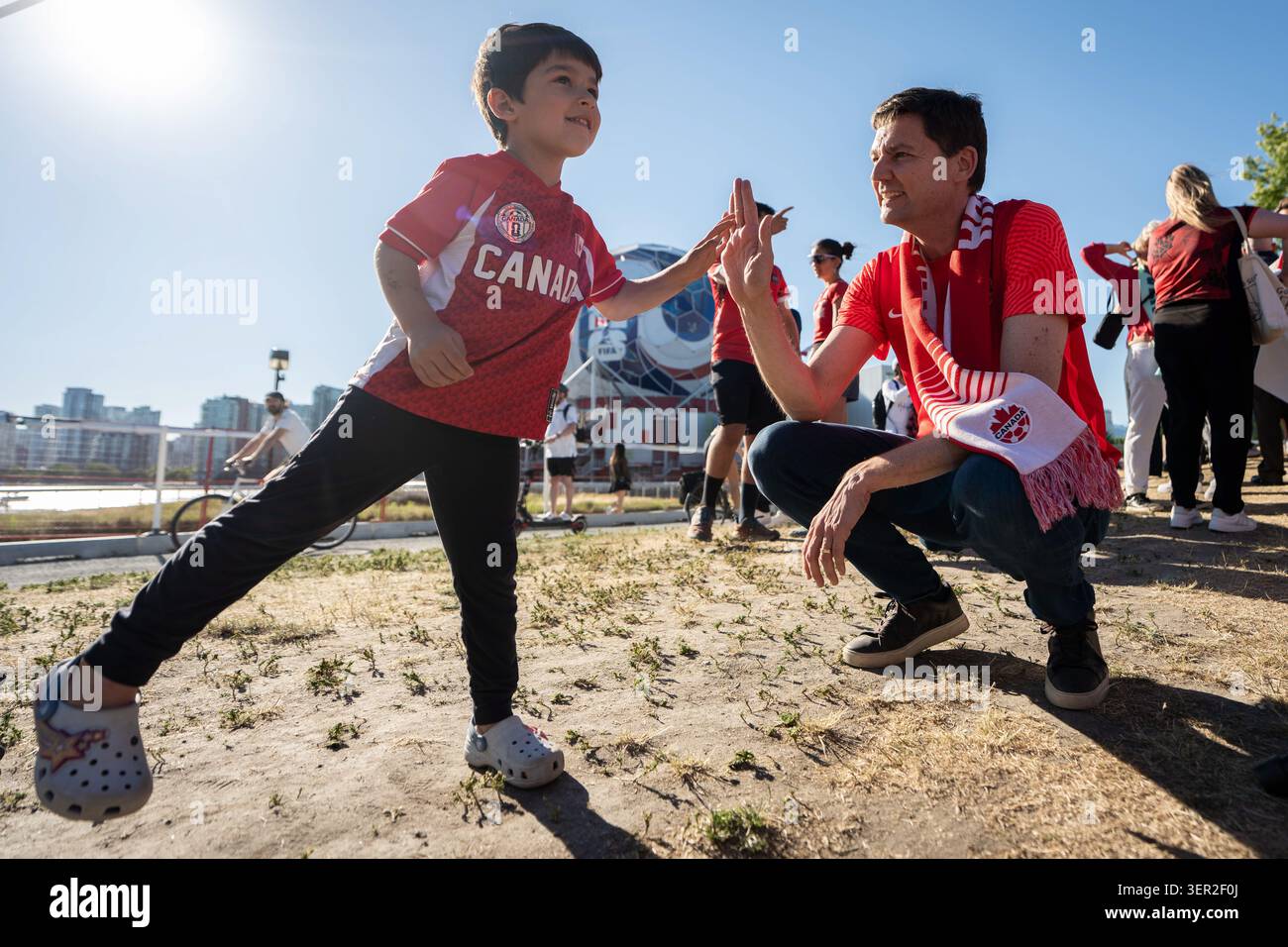 B.C. Premier David Eby high fives a soccer fan during a rally, in ...