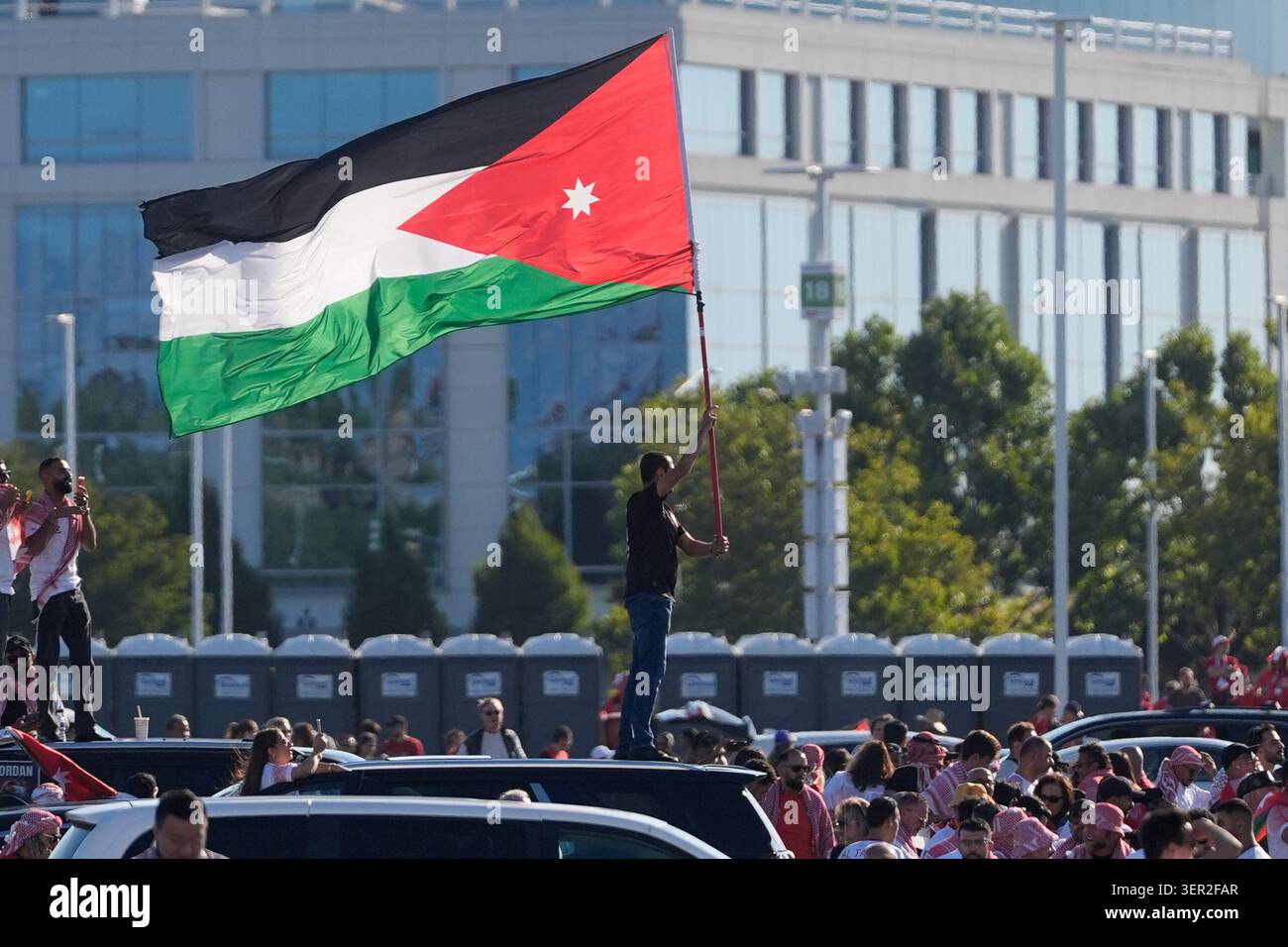 A fan holds a Jordanian flag prior to the World Cup Group J soccer ...