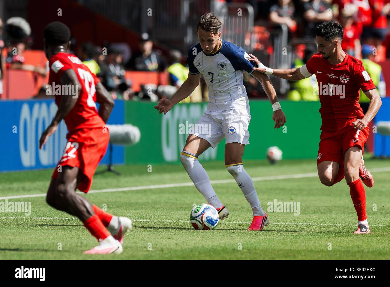 Amar Dedic of Bosnia and Herzegovina competes for the ball with Richie ...