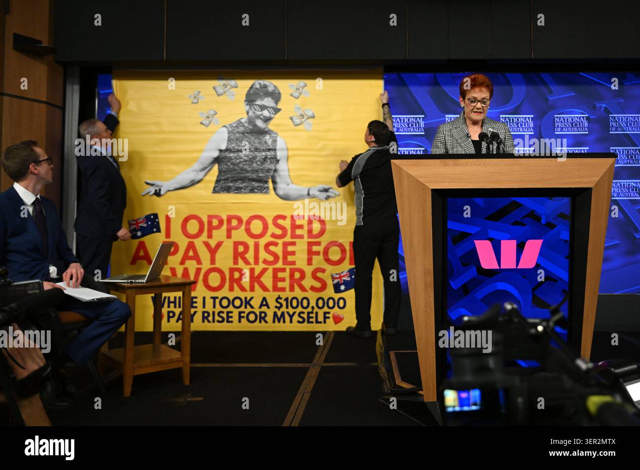 Press Club staff remove a banner seen behind One Nation leader Pauline ...