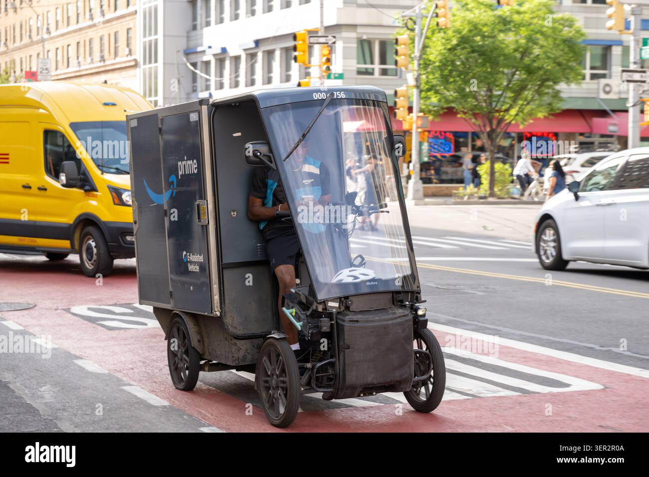 An Amazon delivery worker rides a battery-powered e-cargo bike in ...