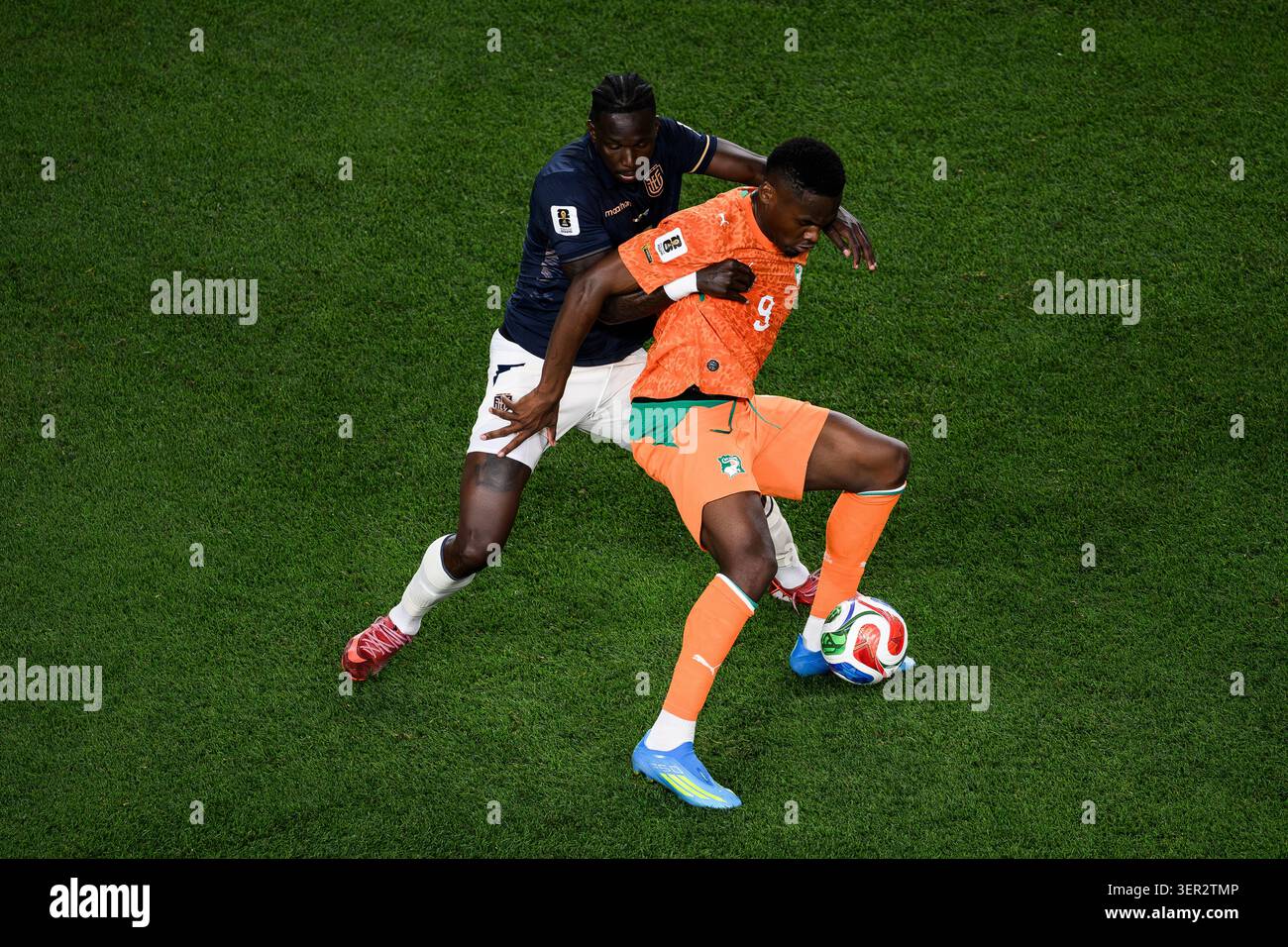 Ange-Yoan Bonny of Cote d'Ivoire competes for the ball with Jackson ...