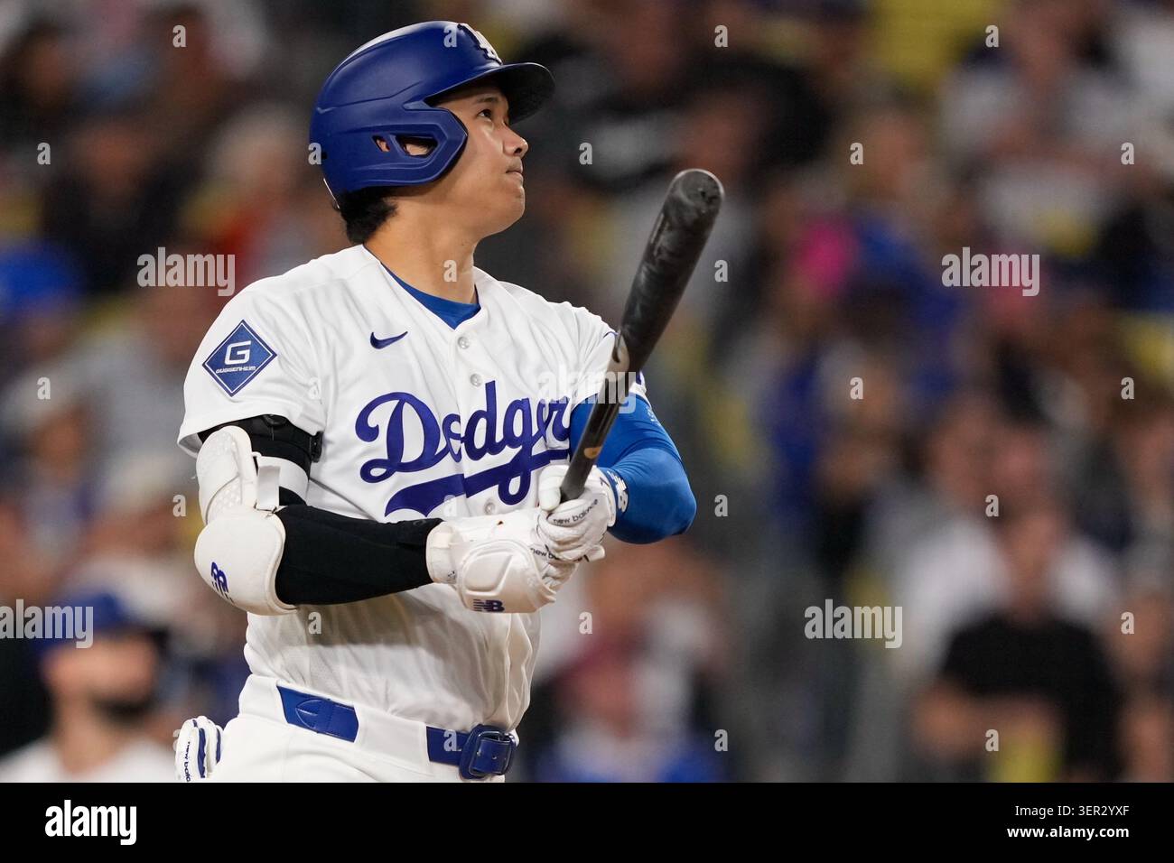 Los Angeles Dodgers' Shohei Ohtani watches his ball go out for a solo ...