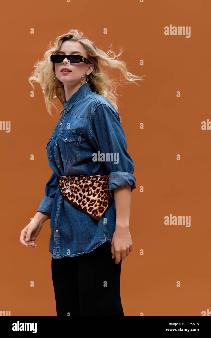 Blonde woman confidently embraces her trendy denim style in a vibrant ...