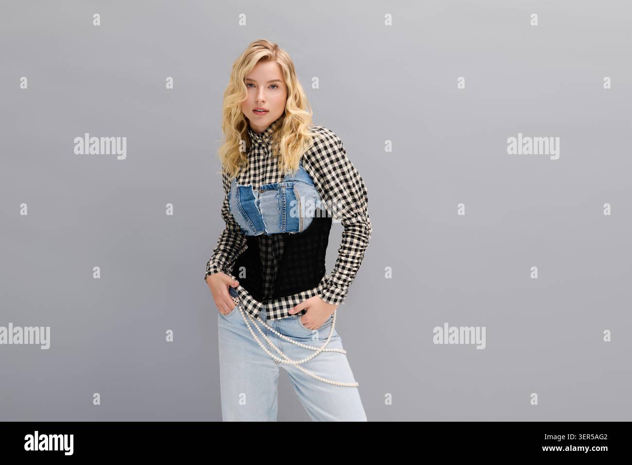 Blonde woman confidently displays her unique denim outfit and trendy ...