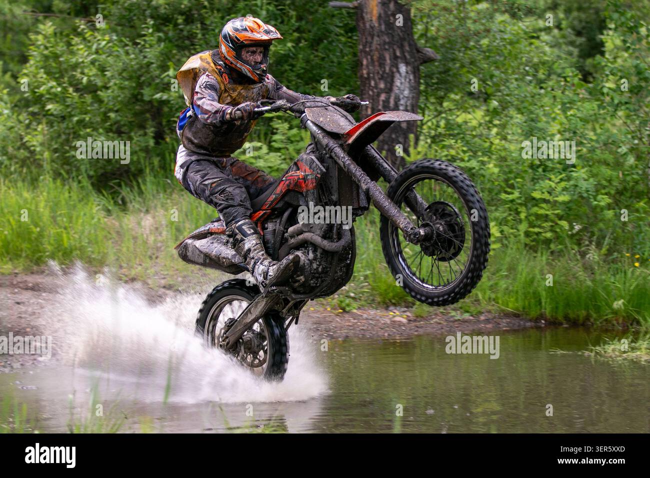 Kyshtym, Russia - June 21, 2015: enduro racer rides on rear wheel a ...