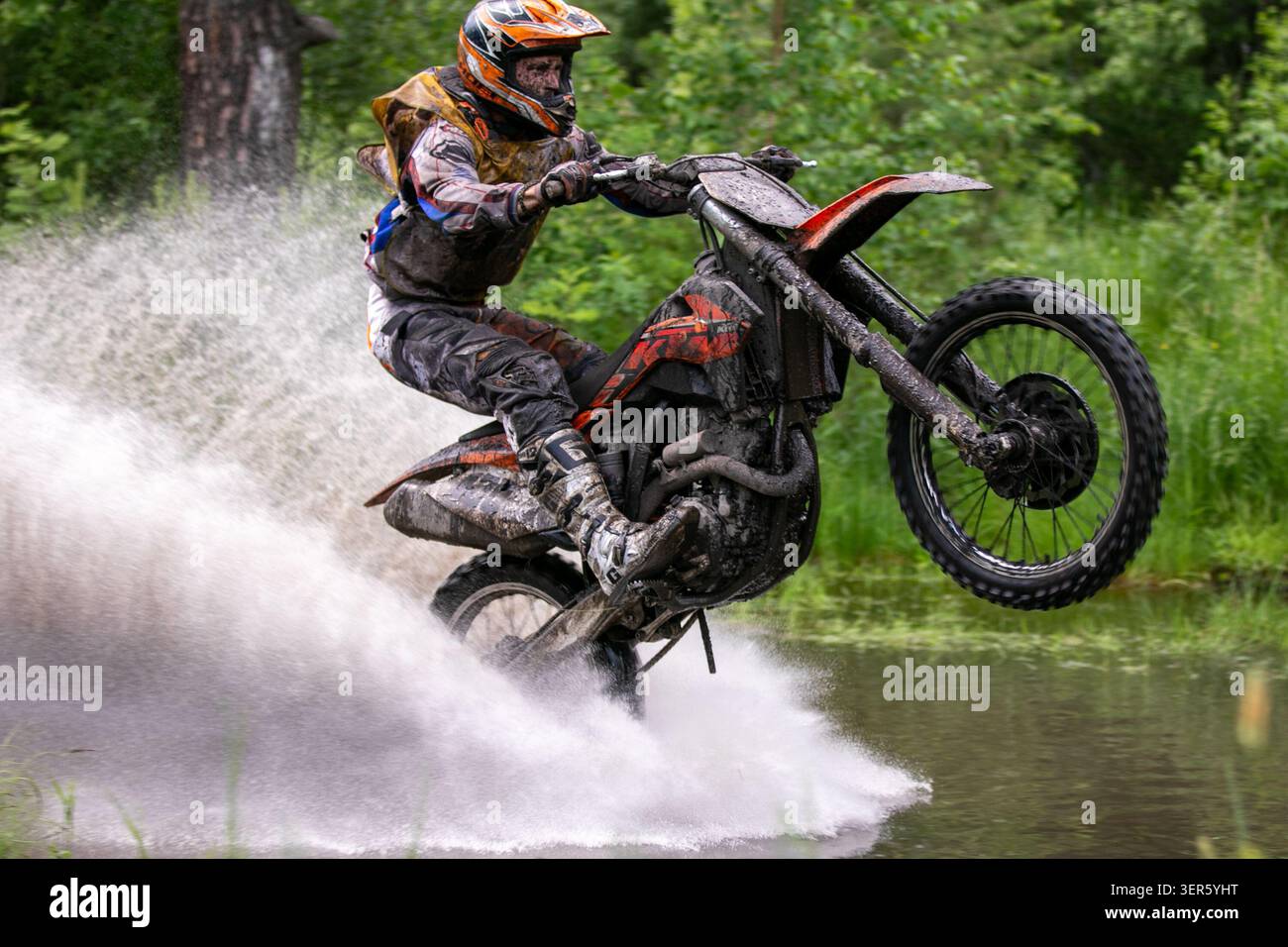Kyshtym, Russia - June 21, 2015: enduro racer rides on rear wheel a ...
