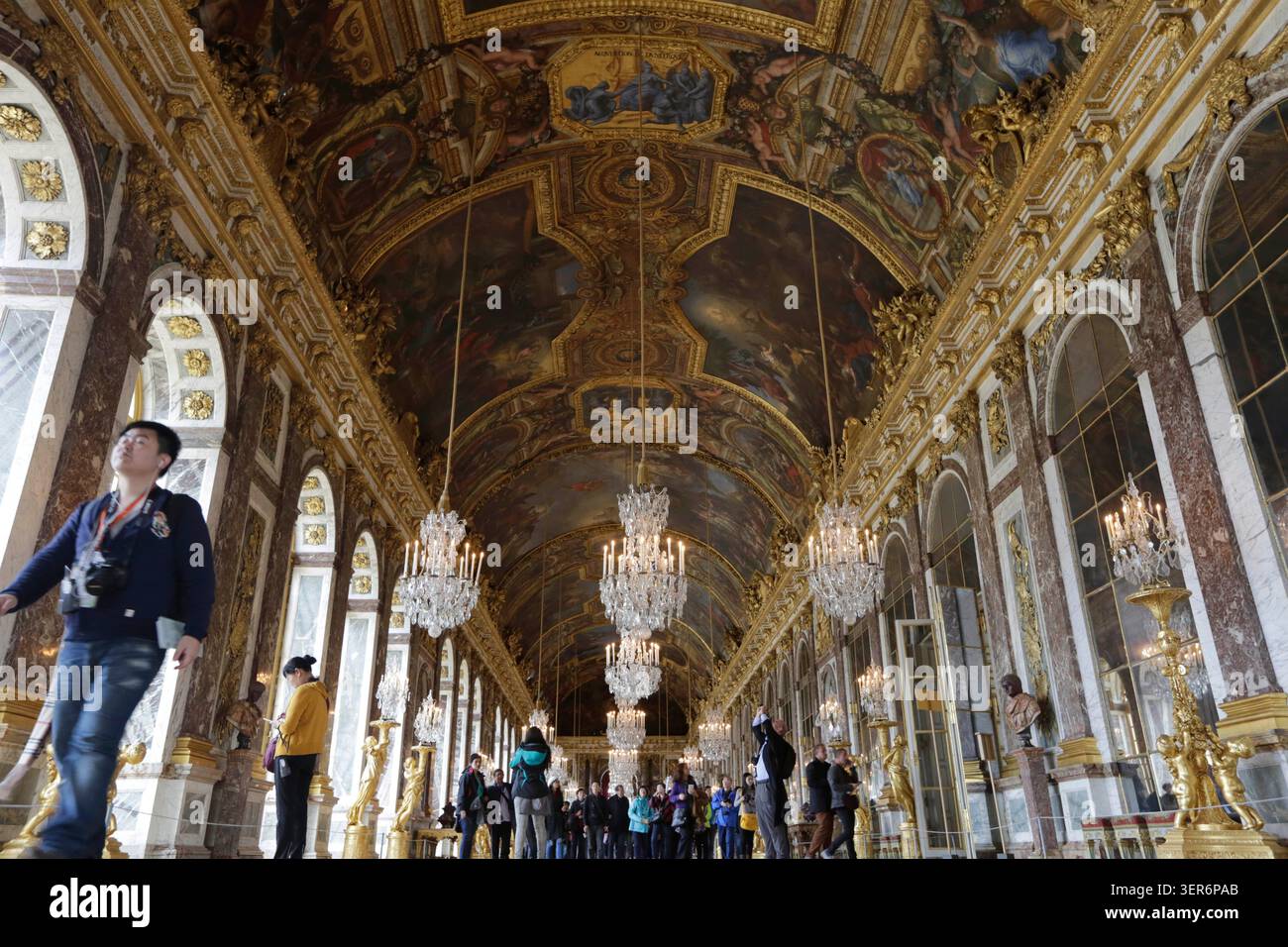 FILE - Visitors walk inside the Hall of Mirrors in the Versailles ...