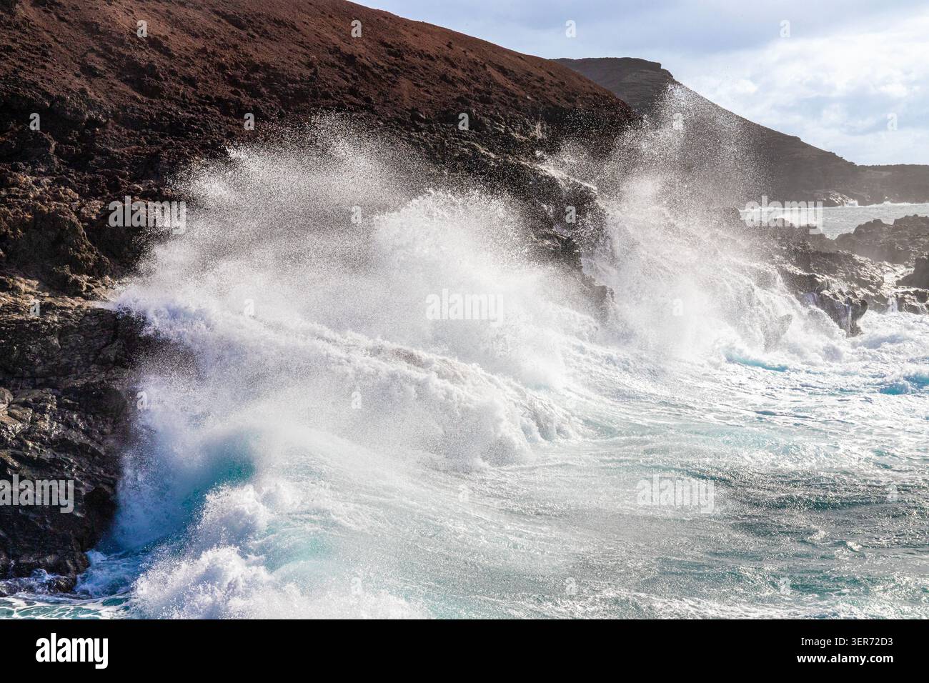 Heavy seas breaking on volcanic rocks at El Golfo on the south west ...