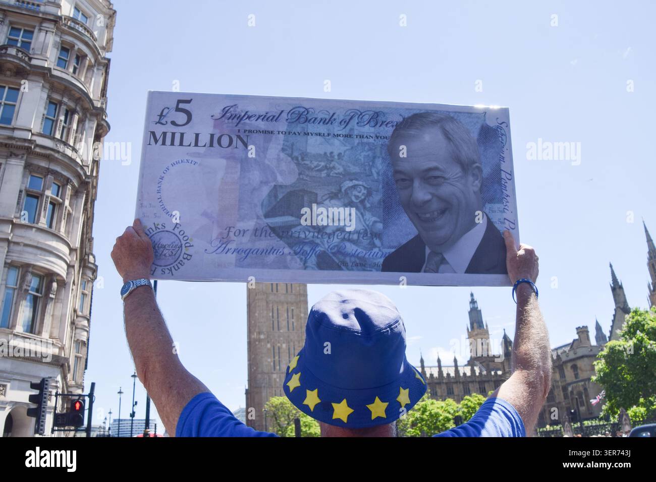 London, UK. 17th June 2026. An activist holds a large mock 5 million ...