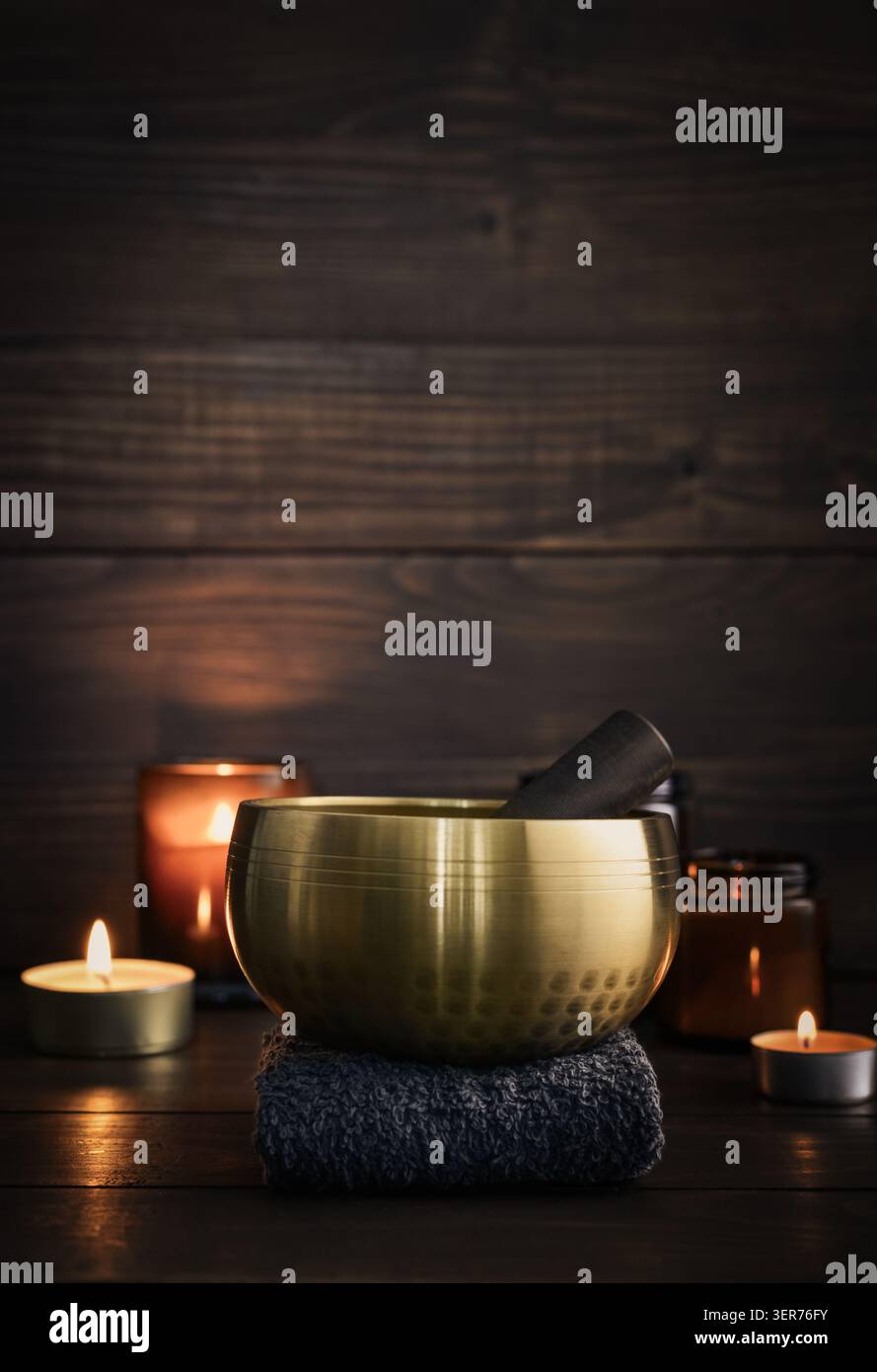 A calming wellness scene featuring a singing bowl surrounded by candles ...