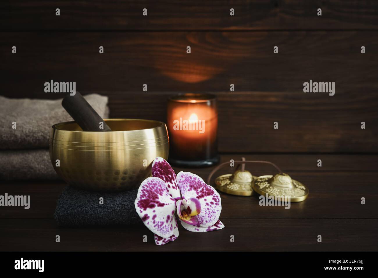 A calming wellness scene featuring a singing bowl surrounded by candles ...