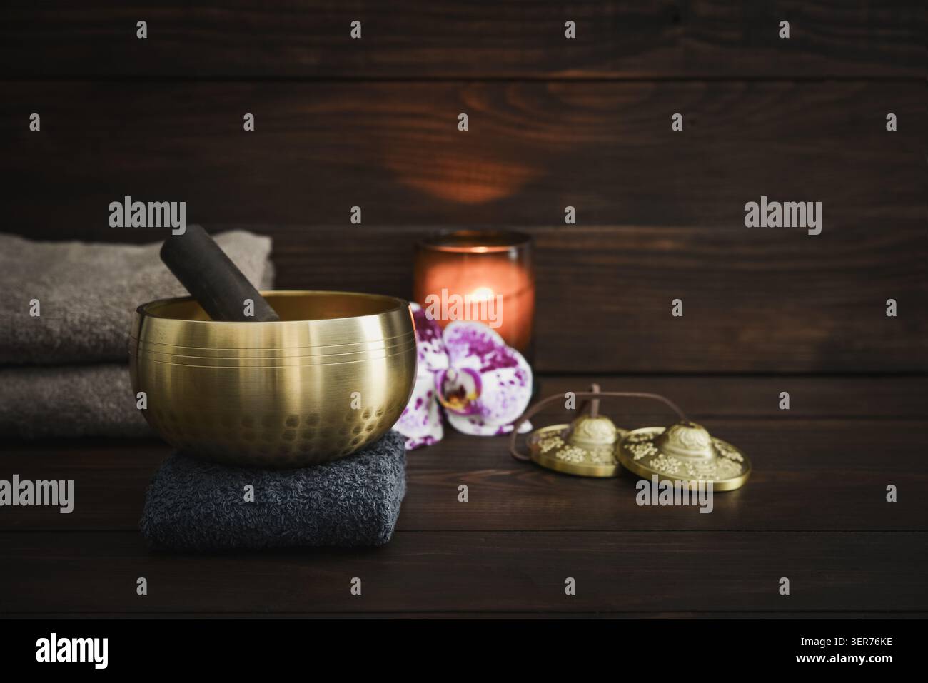 A calming wellness scene featuring a singing bowl surrounded by candles ...