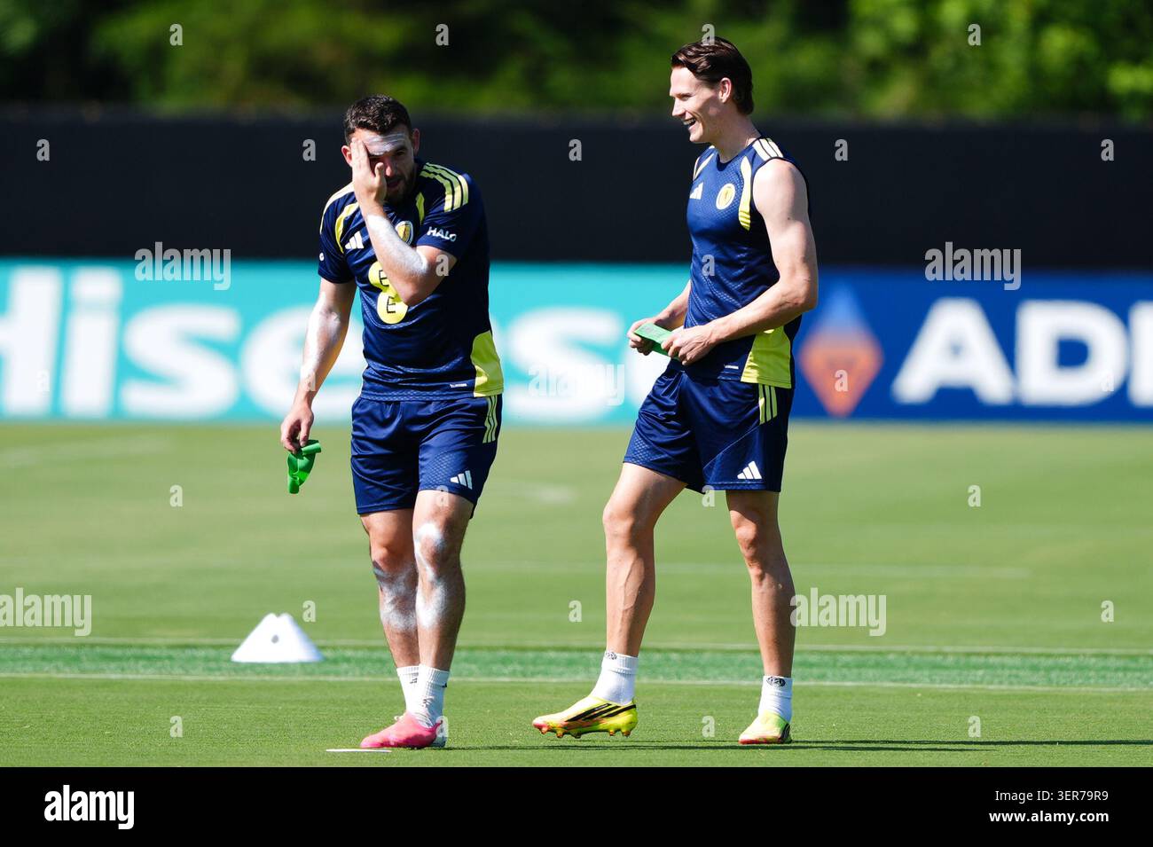 Scotland's John McGinn applies sun cream as Scott McTominay laughs ...