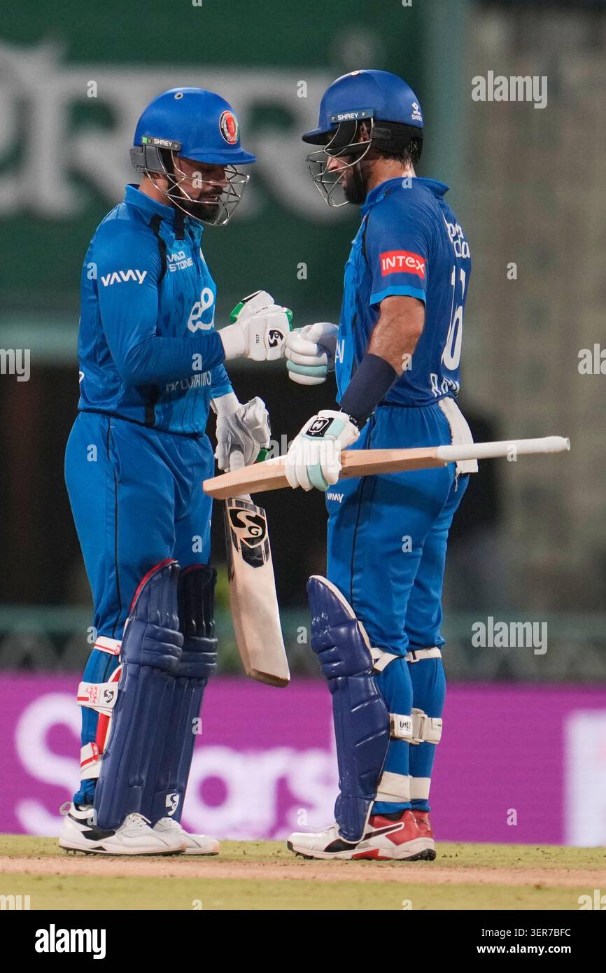 Afghanistan's Rahmat Shah, right, celebrates his fifty runs with ...