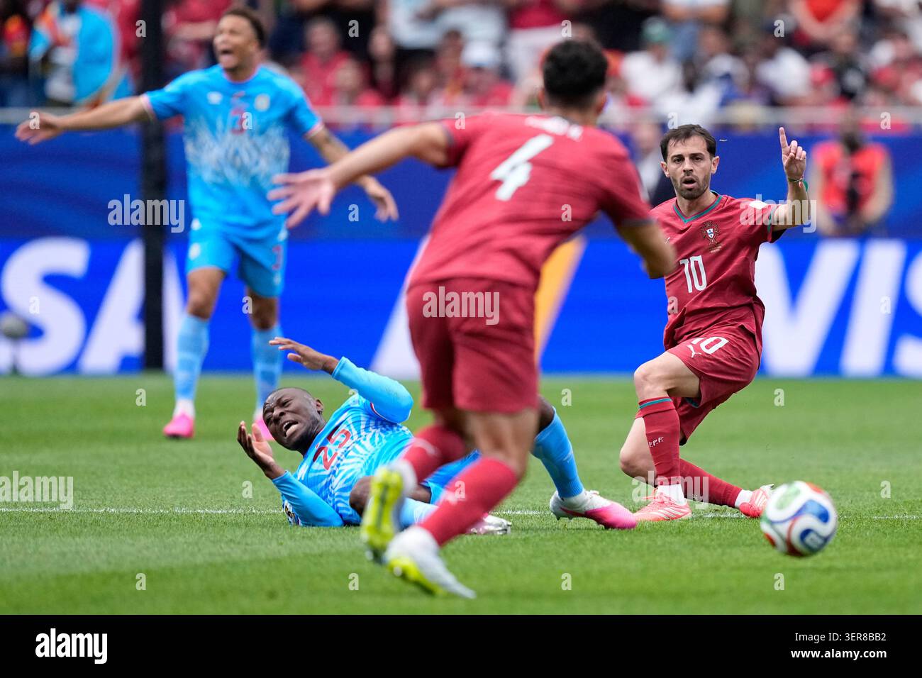 Congo's Edo Kayembe, on the ground, grimaces after being fouled by ...