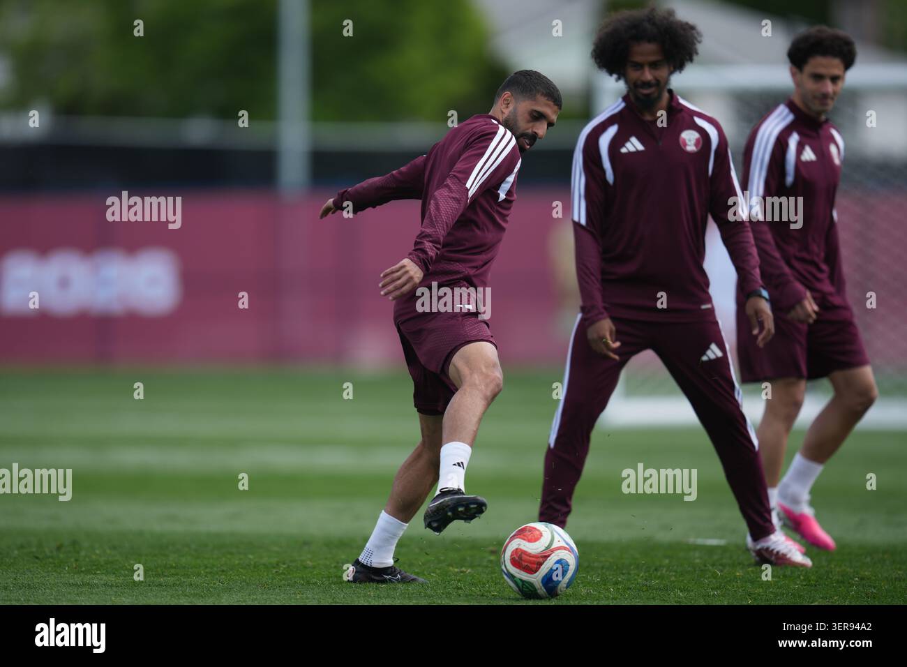 Qatar's Hassan Alhaydos, left, works out during a training session on ...